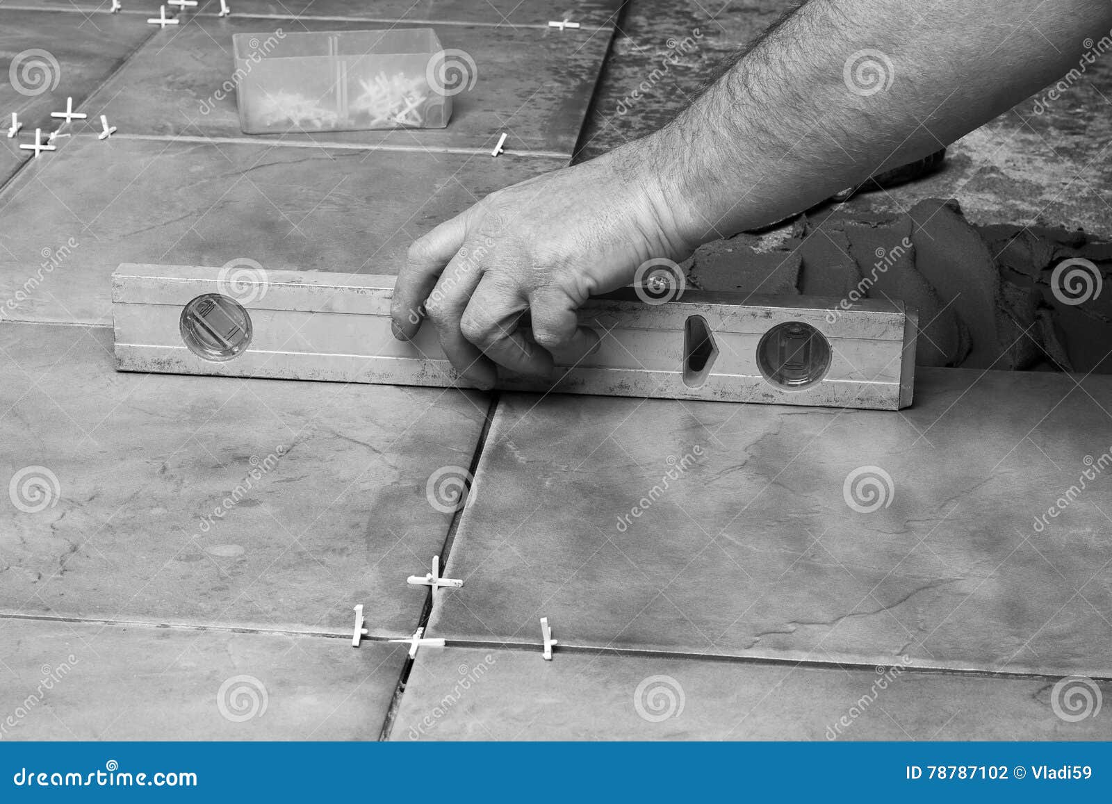 Laying ceramic tiles. stock photo. Image of closeup, interior - 78787102