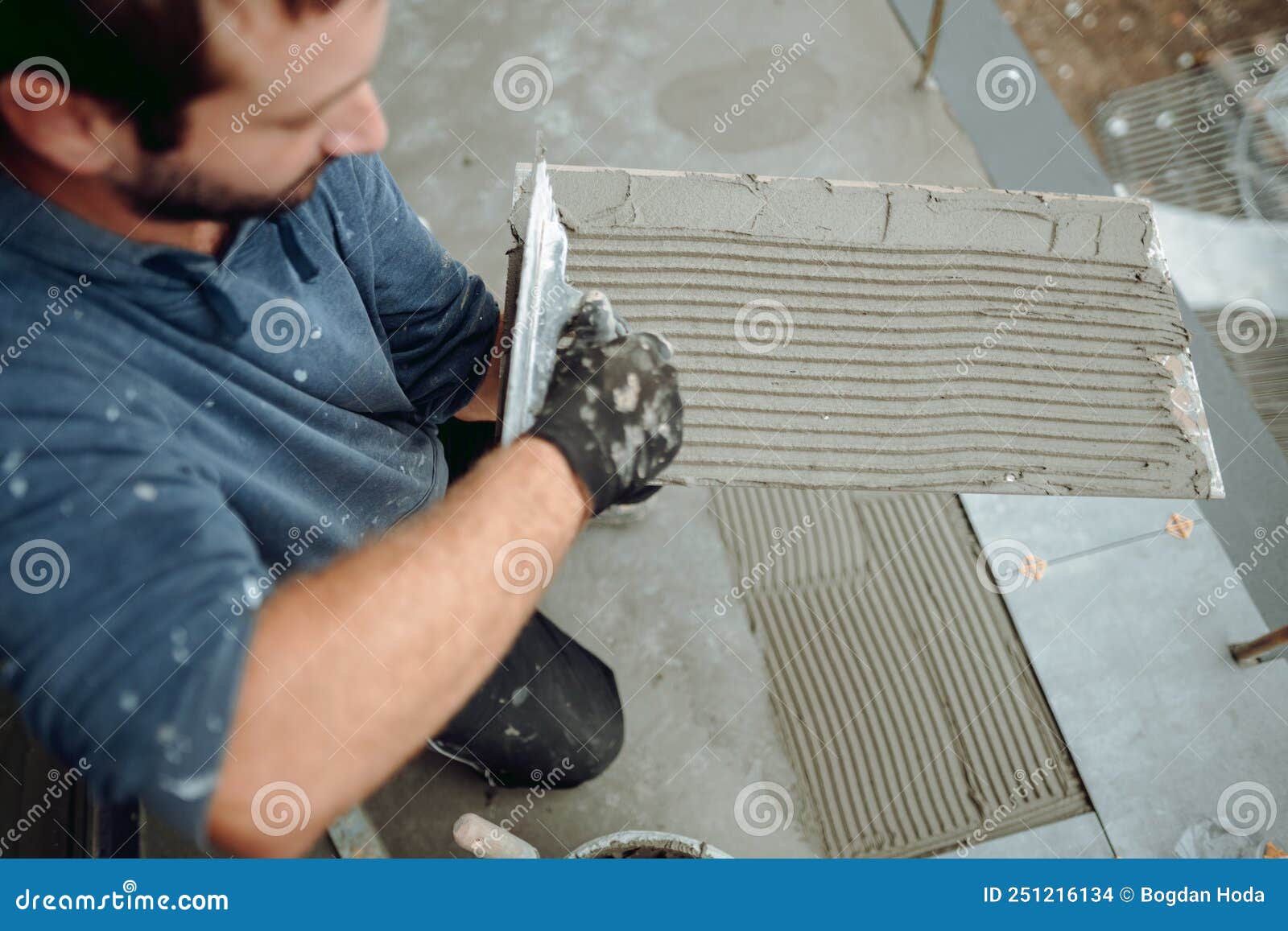 Worker Placing Ceramic Floor Tile in Position Over Adhesive Stock Photo ...
