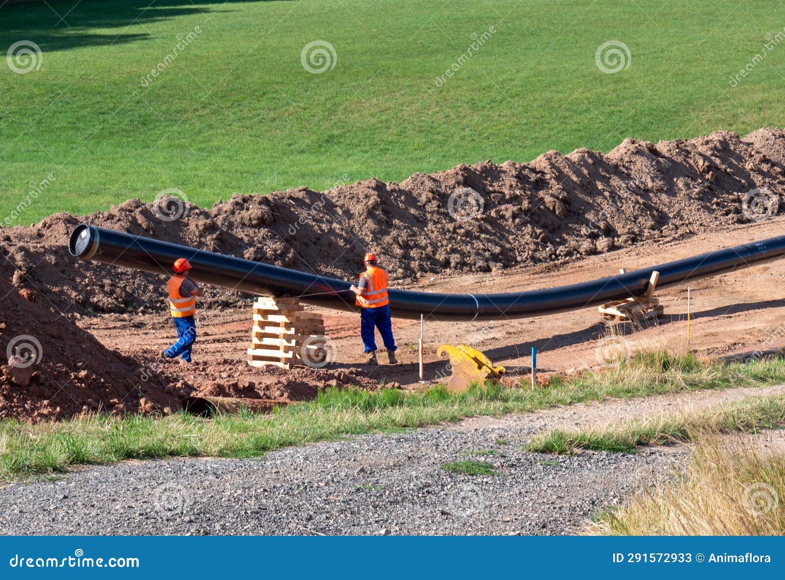 Laying a Gas Pipe Route on the Construction Site with Worker Stock ...