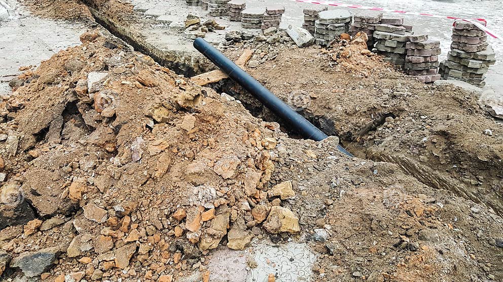 Laying Installation of a New Cable in a Plastic Pipe. Digging Drilling ...