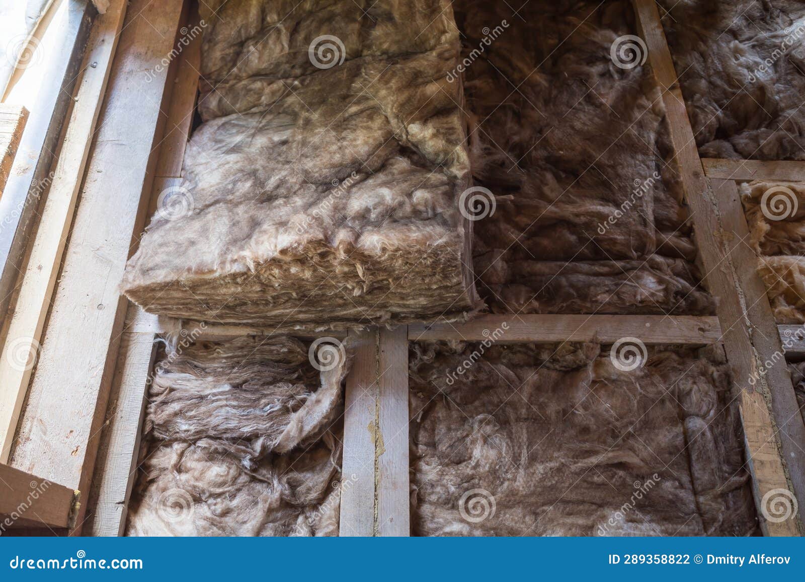 Laying Insulation on the Floor in a Frame House Under Construction ...