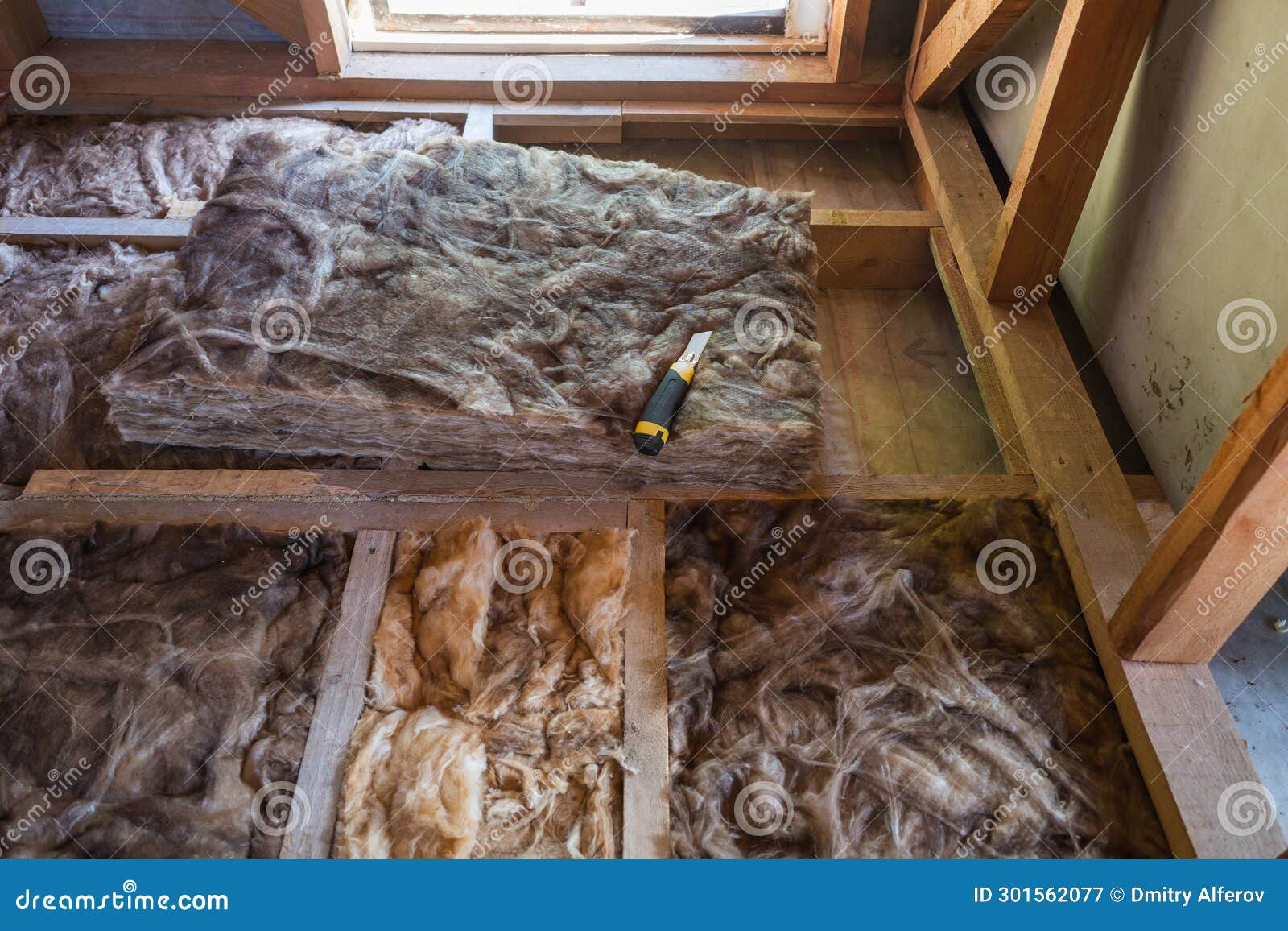 Laying Insulation on the Floor in a Frame House Under Construction ...
