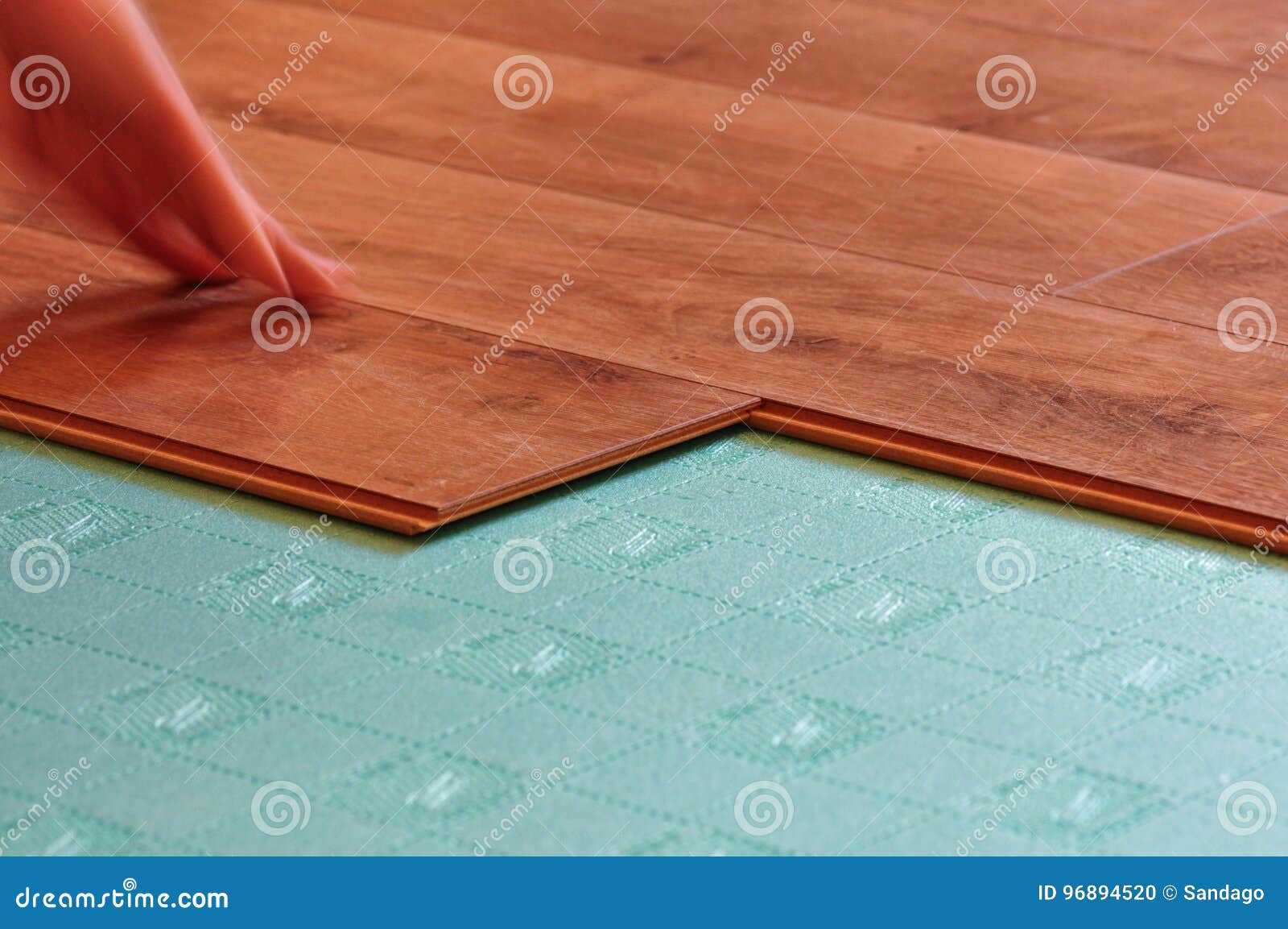 Laying Laminate Flooring With Your Own Hands. The Master Lays The ...