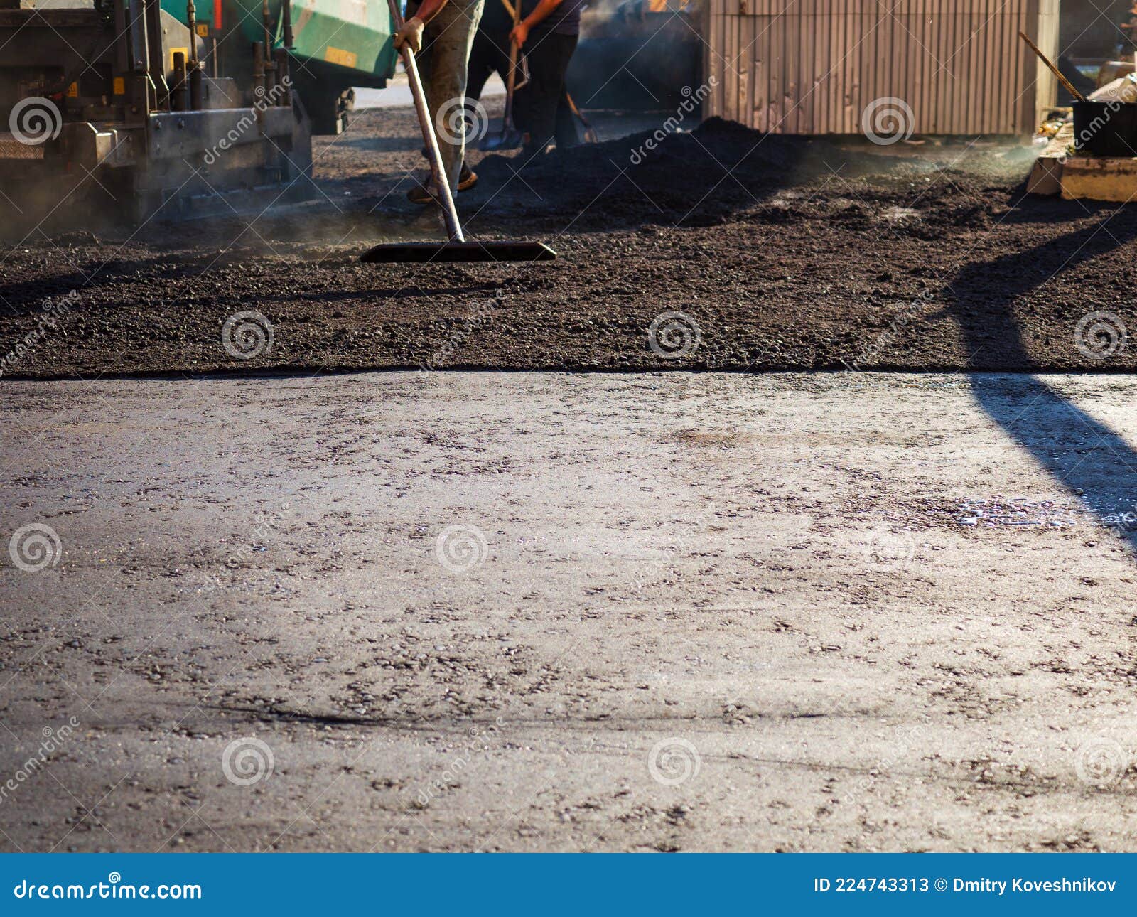Laying New Asphalt. the Process of Leveling the Asphalt Manually Using ...