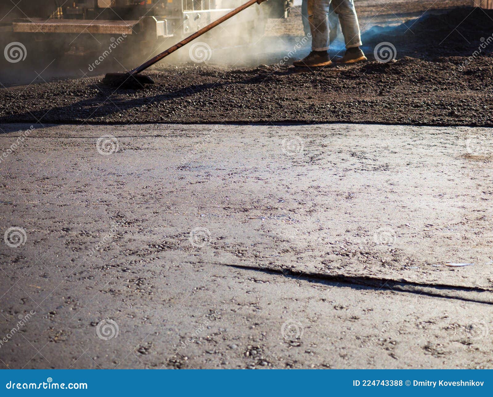 Laying New Asphalt. the Process of Leveling the Asphalt Manually Using ...