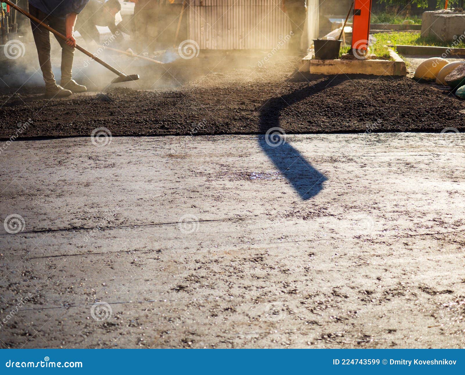 Laying New Asphalt. the Process of Leveling the Asphalt Manually Using ...
