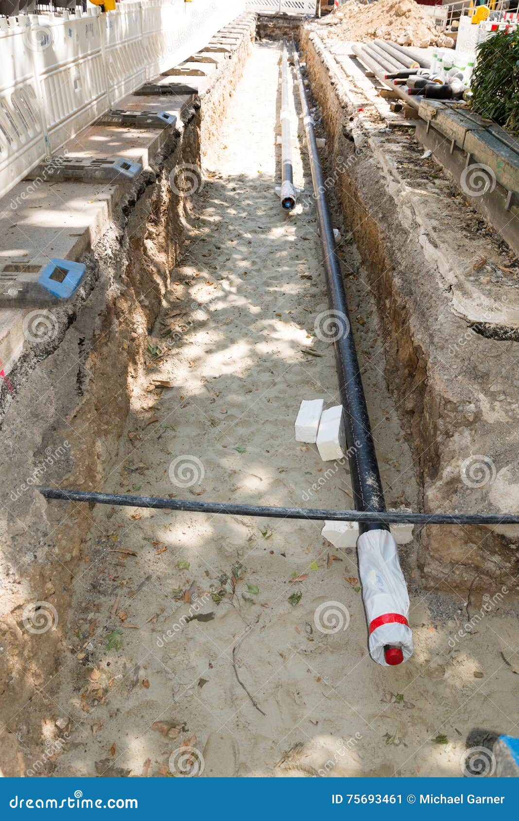 Laying new pipes in trench stock image. Image of scene - 75693461