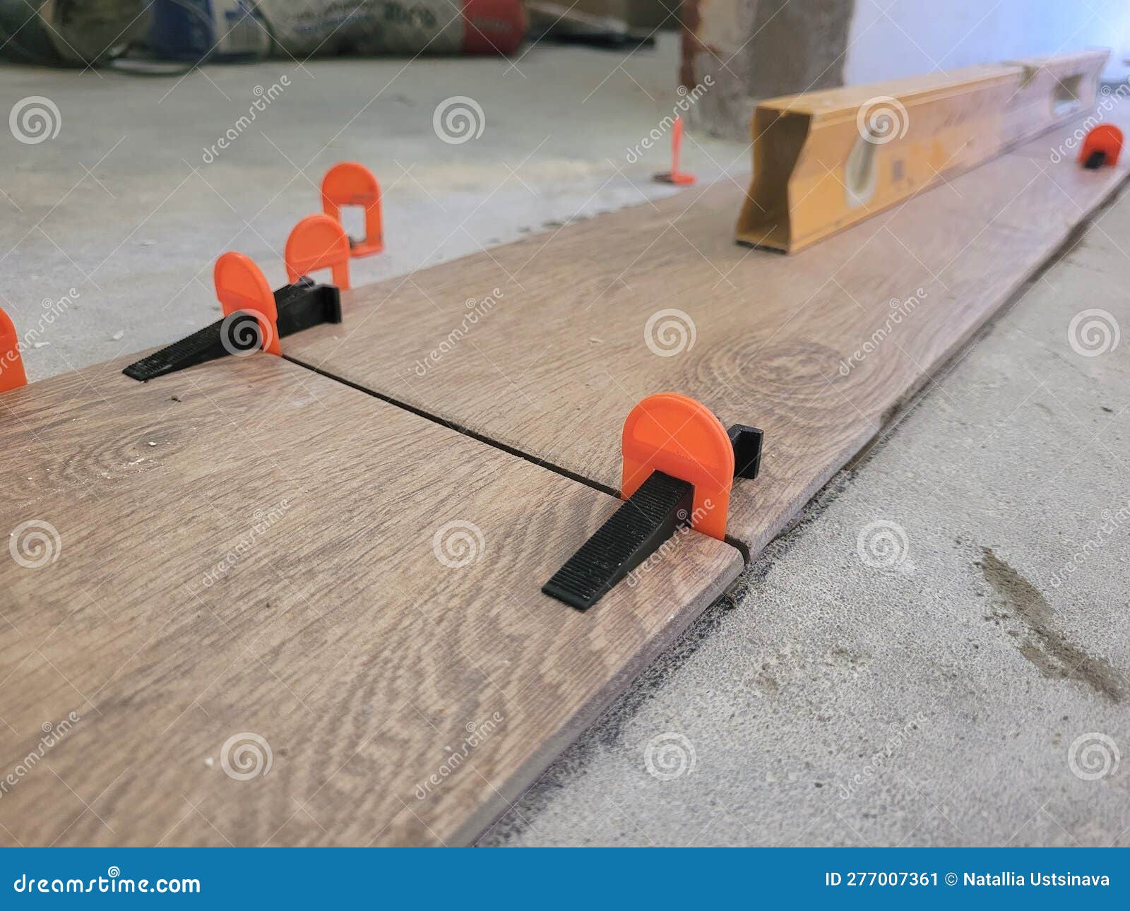 Laying Tiles at Home. Leveling Floor Tiles with a Level Stock Image ...