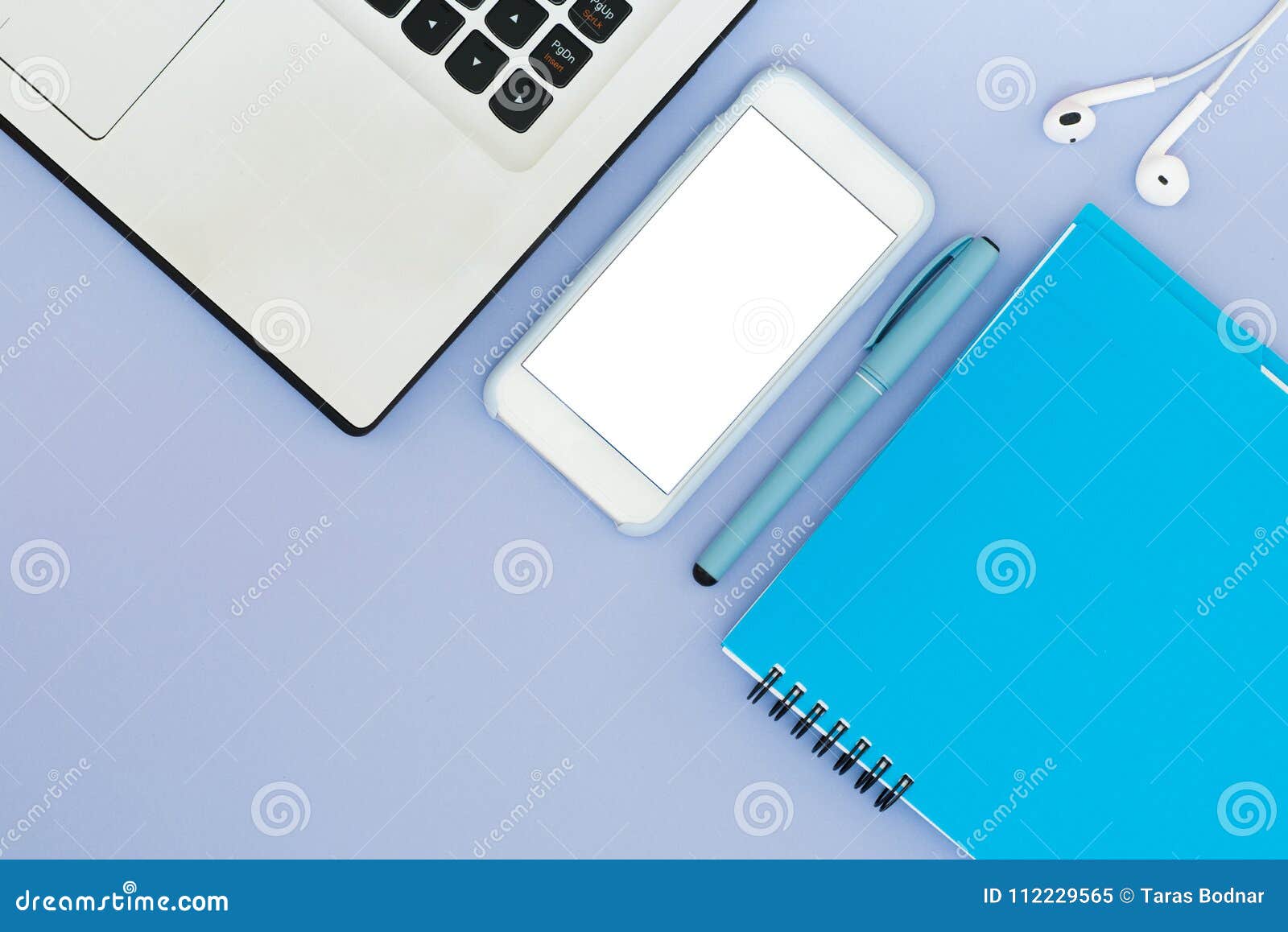 Layout with a Laptop, Phone, Notepad and Headphones on a Blue ...