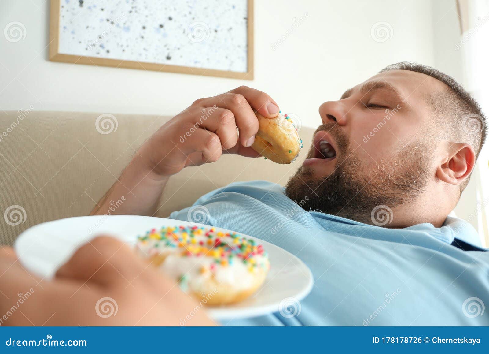 Lazy Overweight Man Eating Donuts at Home Stock Photo - Image of adult ... Lazy Overweight Man Eating Donuts at Home Stock Photo - Image of adult ...