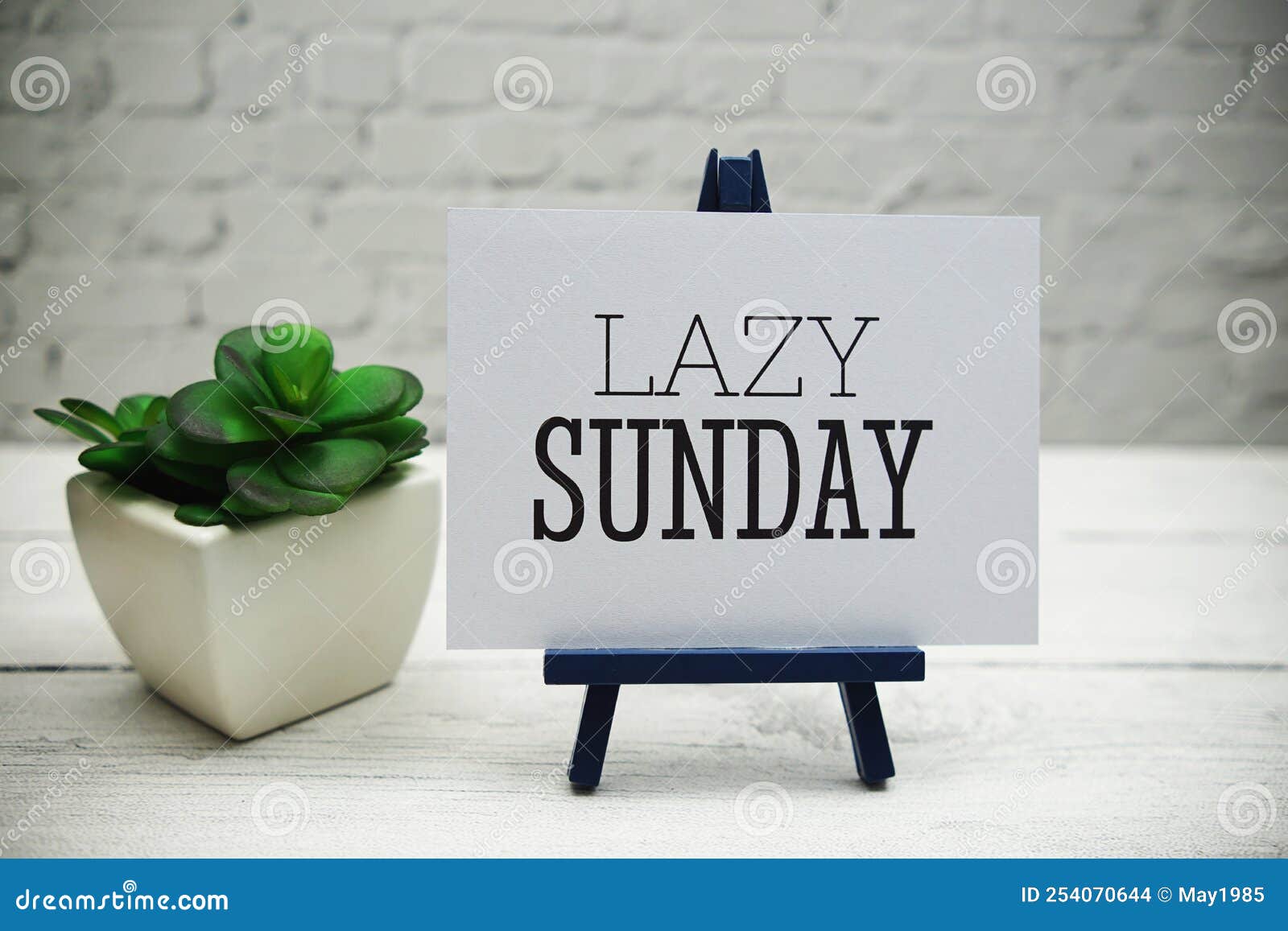 Lazy Sunday Text on White Brick Wall and Wooden Background Stock Photo ...
