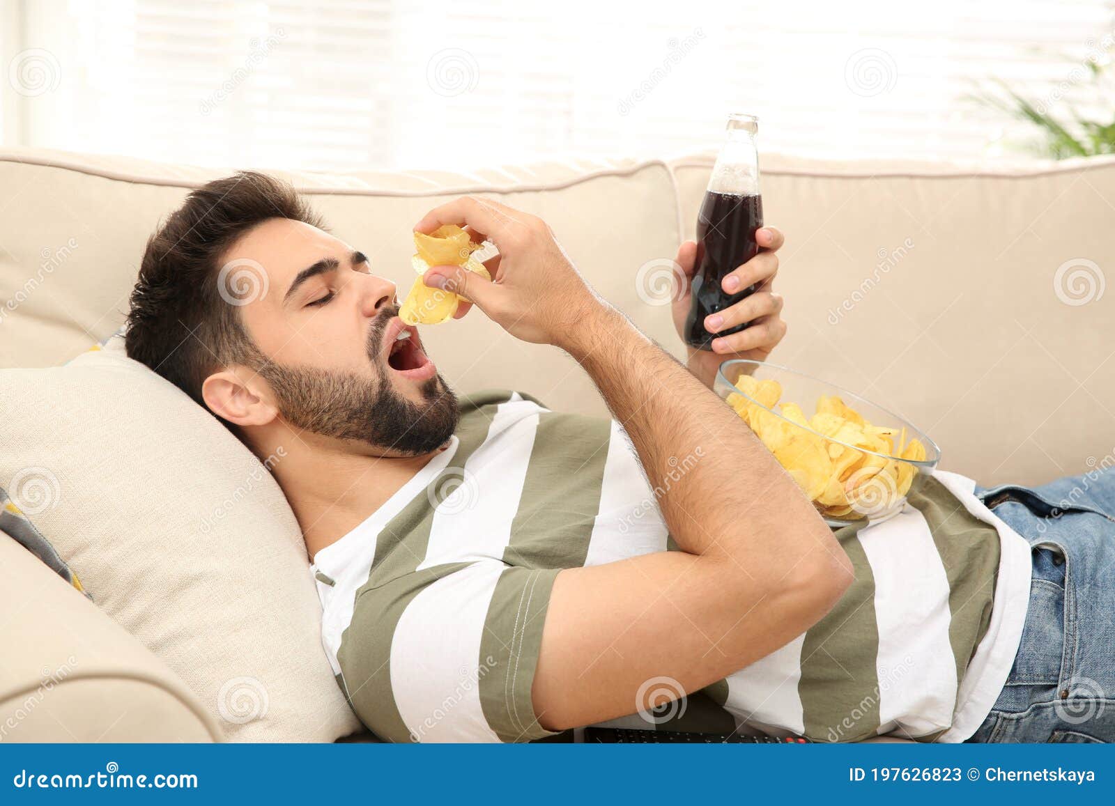 Lazy Young Man with Chips and Drink on Sofa Stock Image - Image of ...