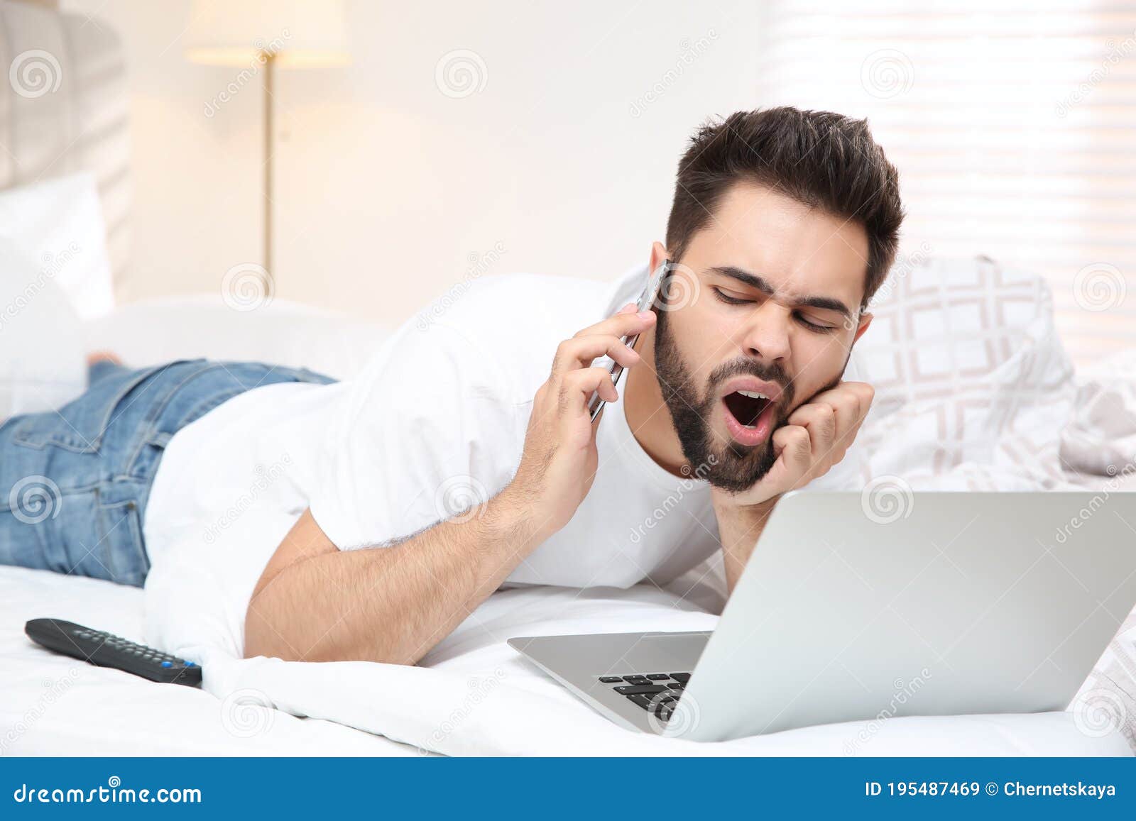 Lazy Man with Laptop and Smartphone on Bed at Home Stock Image - Image ...