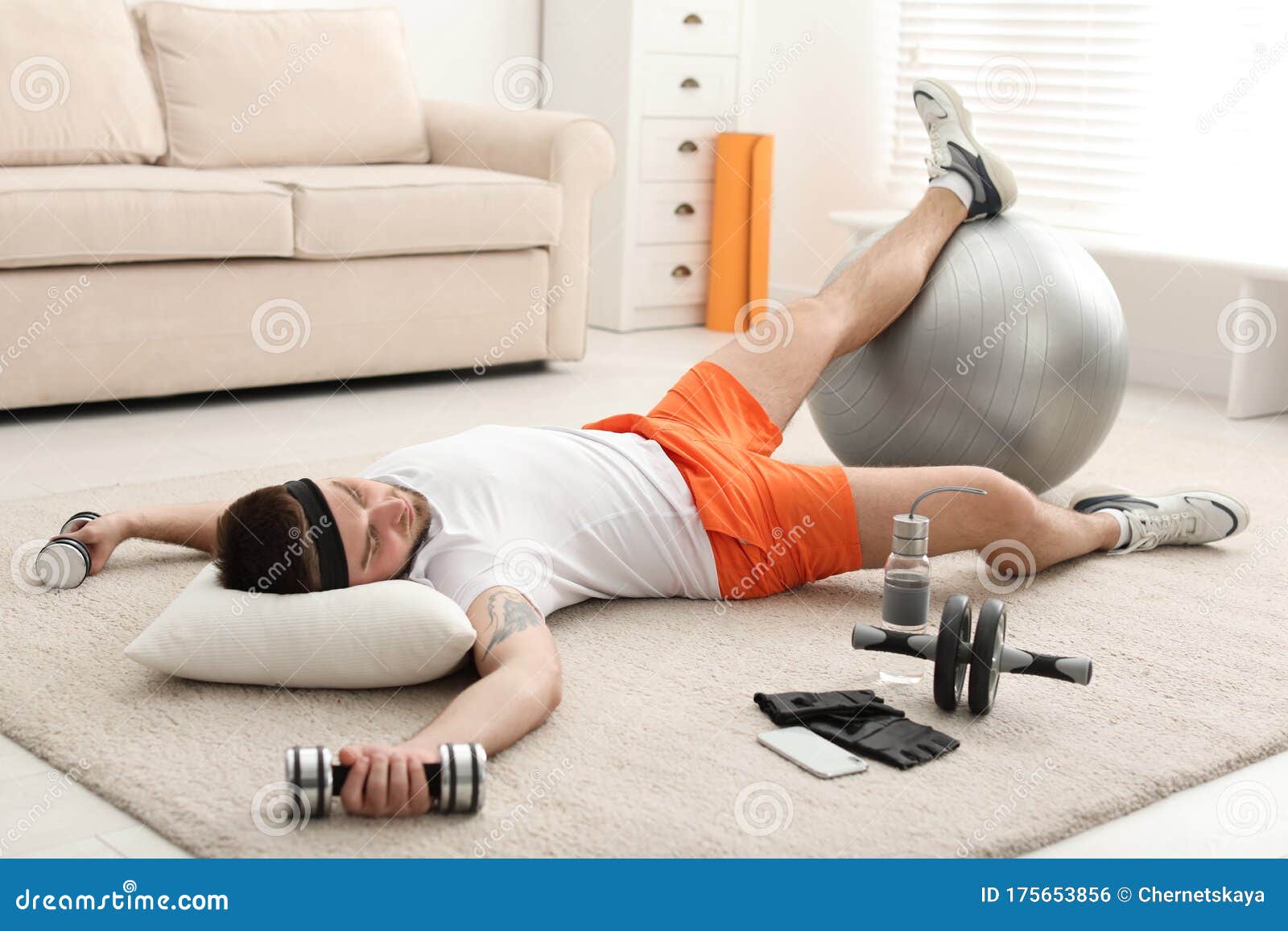 Lazy Young Man with Sport Equipment Sleeping on Floor Stock Photo ... Lazy Young Man with Sport Equipment Sleeping on Floor Stock Photo ...