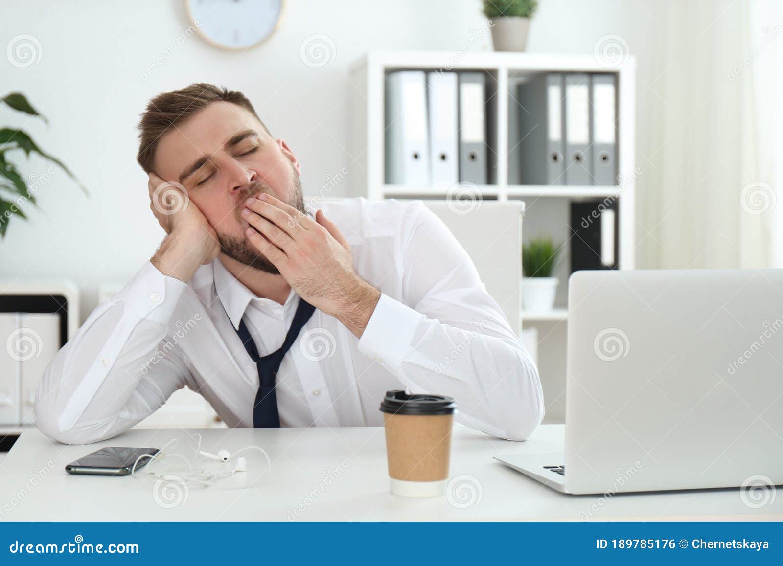 Lazy Young Man Yawning at Table Stock Photo - Image of businessman ...