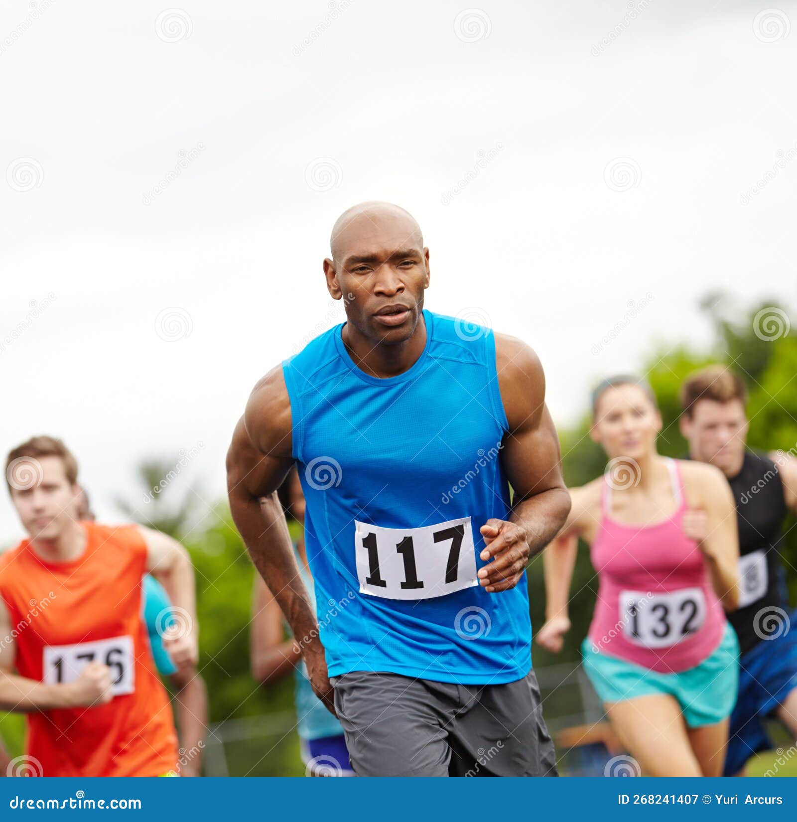 The Leader of the Pack. Front View of a Male Runner in First Place with ...