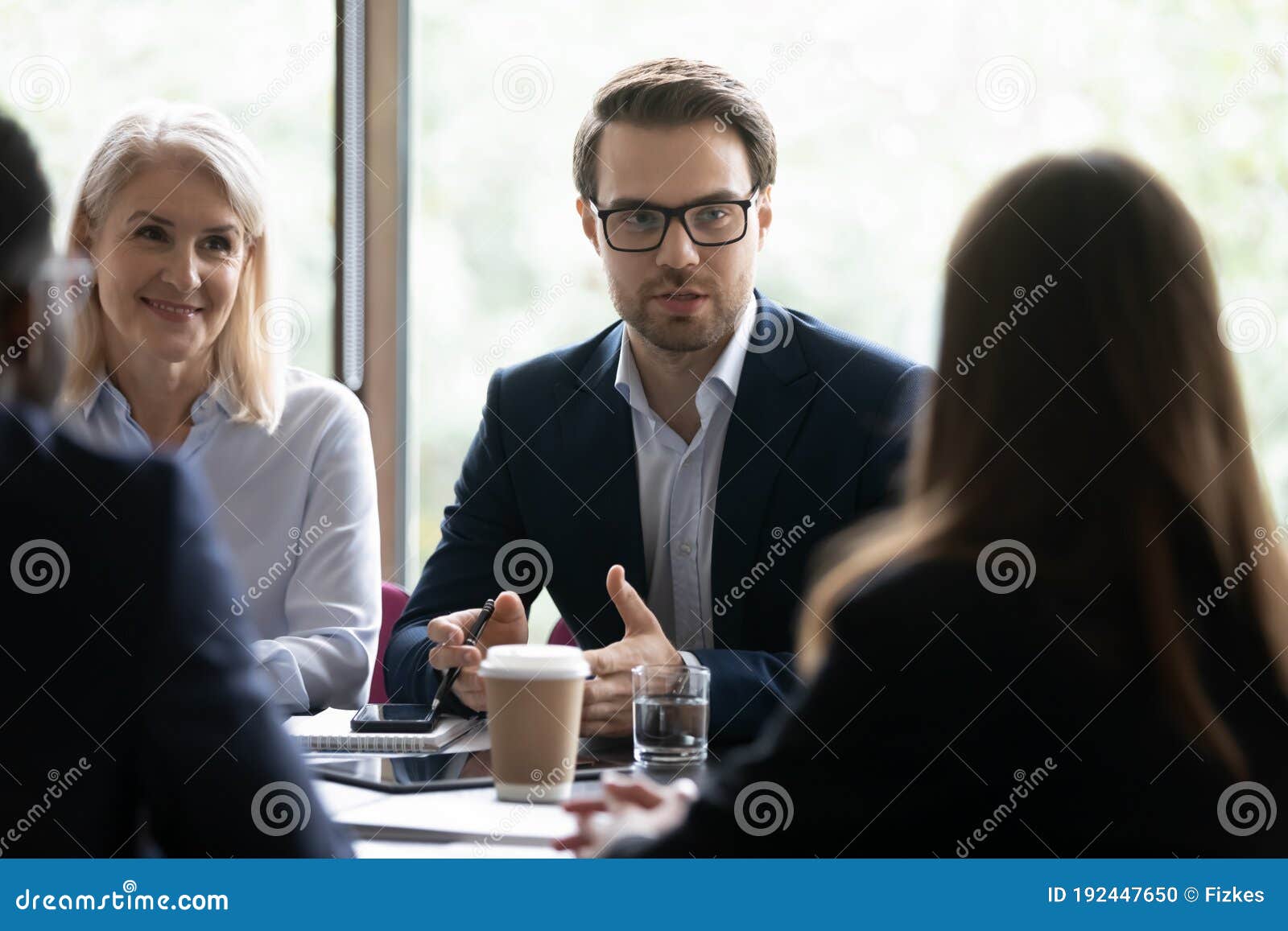 Leader and Colleagues Discussing New Project during Group Meeting Stock ...