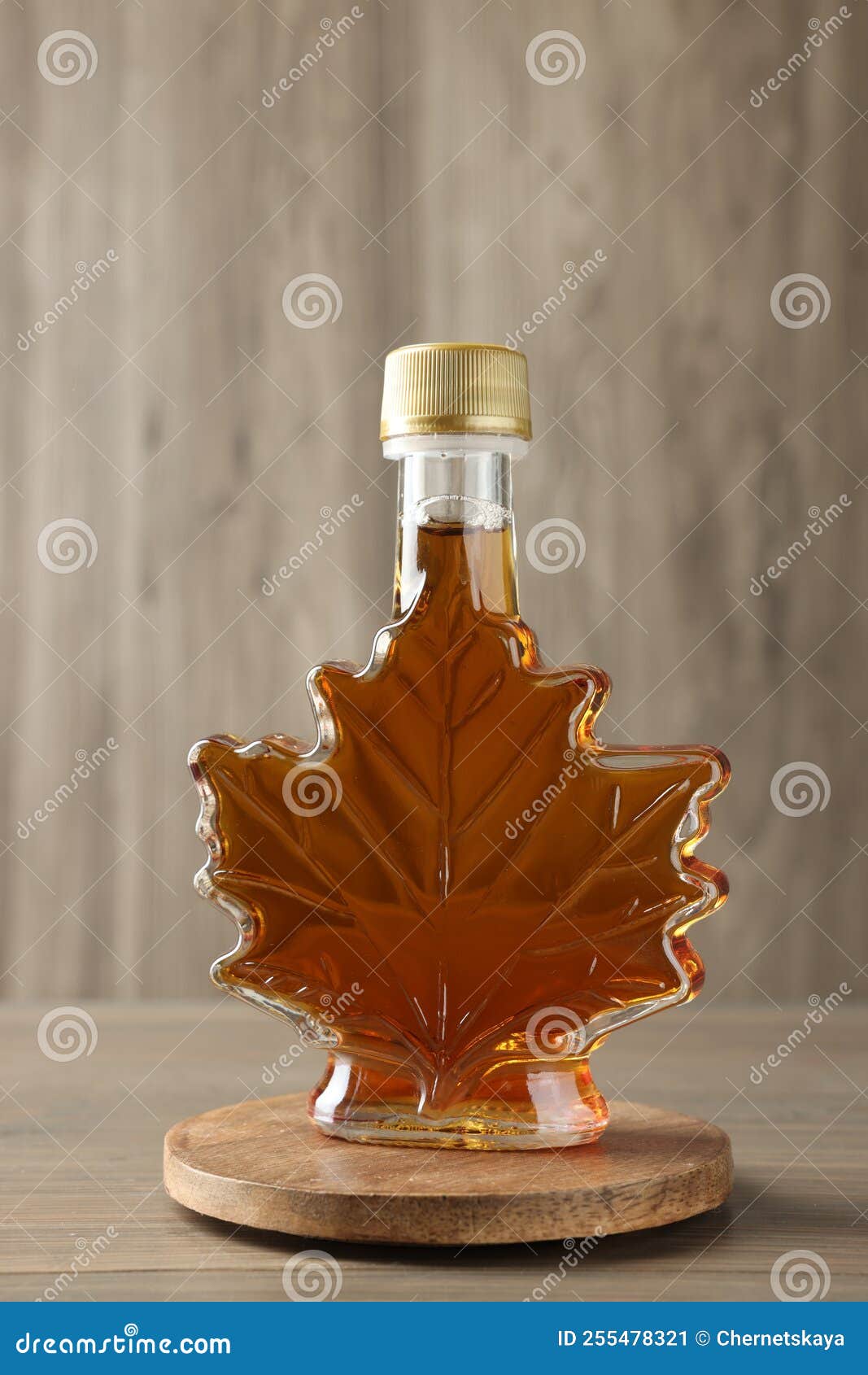 Leaf Shaped Bottle of Tasty Maple Syrup on Wooden Table Stock Image ...