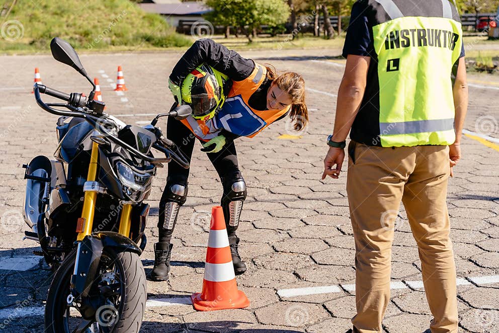 Learner Biker on Test Road with Red Cones. Instructor Writing on ...