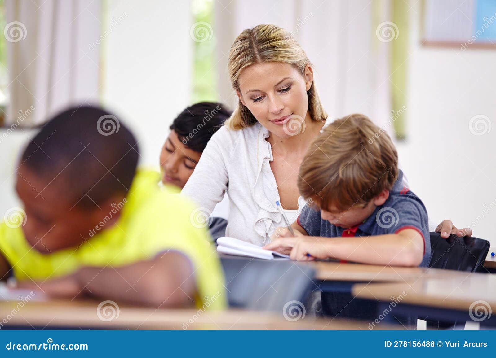 Learning the Basics. a Young Teacher Assisting a Student with Classwork ...