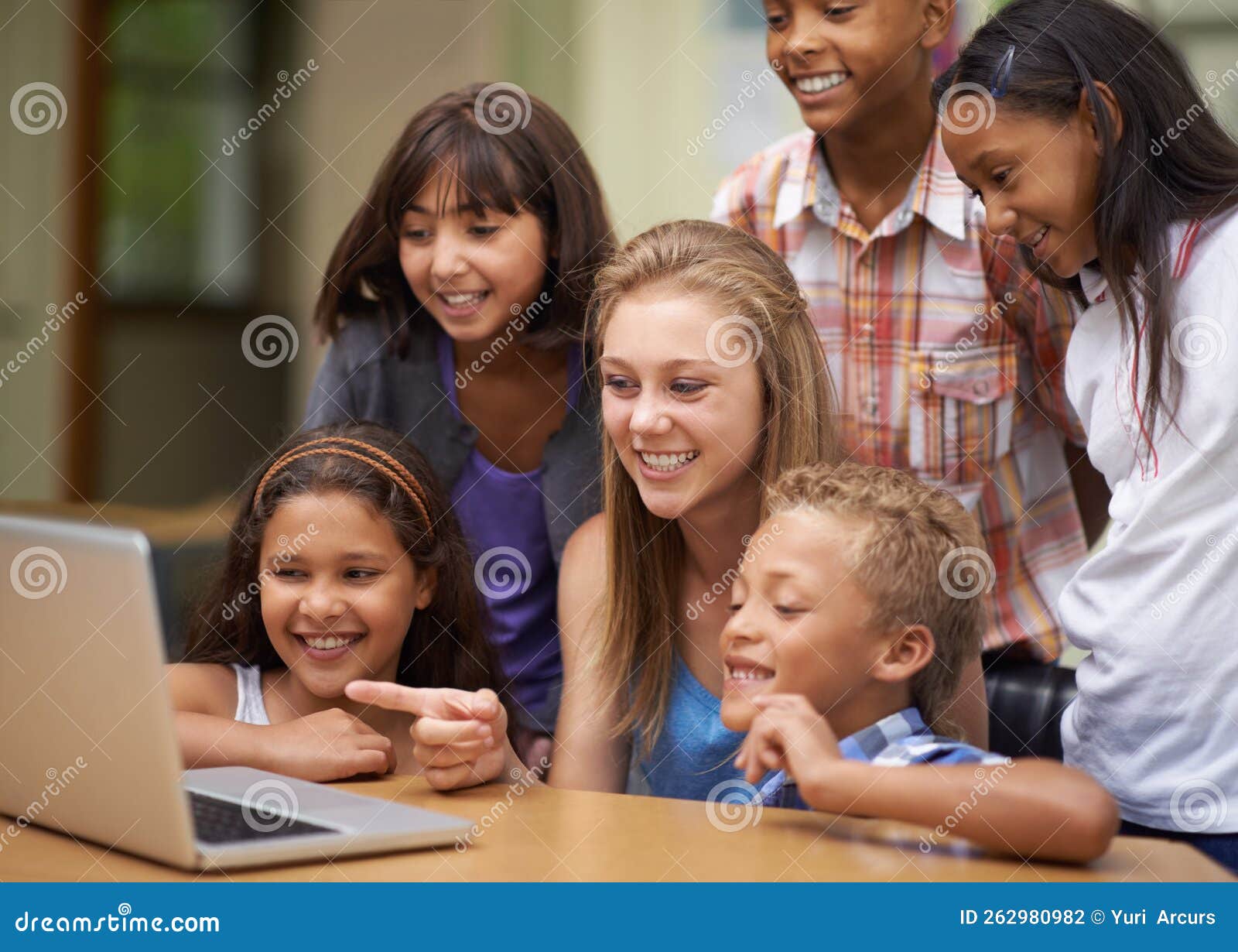 Learning More about Computers. a Group of Pupils Working on a Laptop in ...