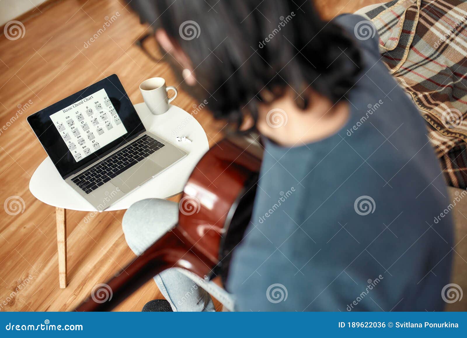 Learning Music Online. Rear View of a Young Man Watching Video Tutorial ...