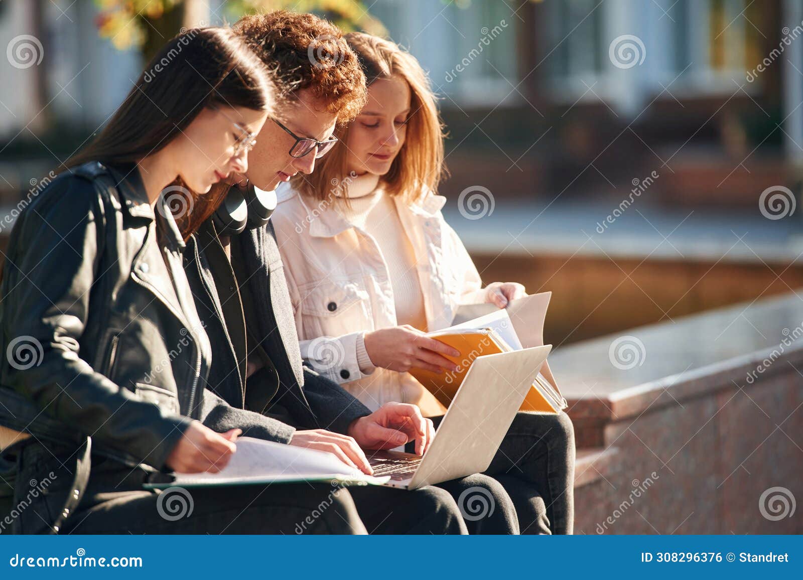 Learning, Sitting and Using Laptop. Three Young Students are Outside ...