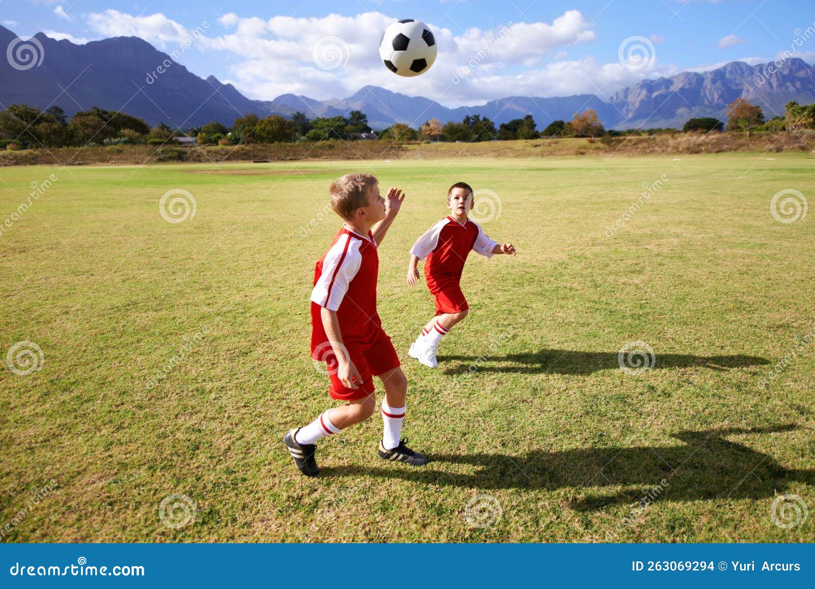 Learning Teamwork while Playing Together. Two Boys Playing Soccer on a ...