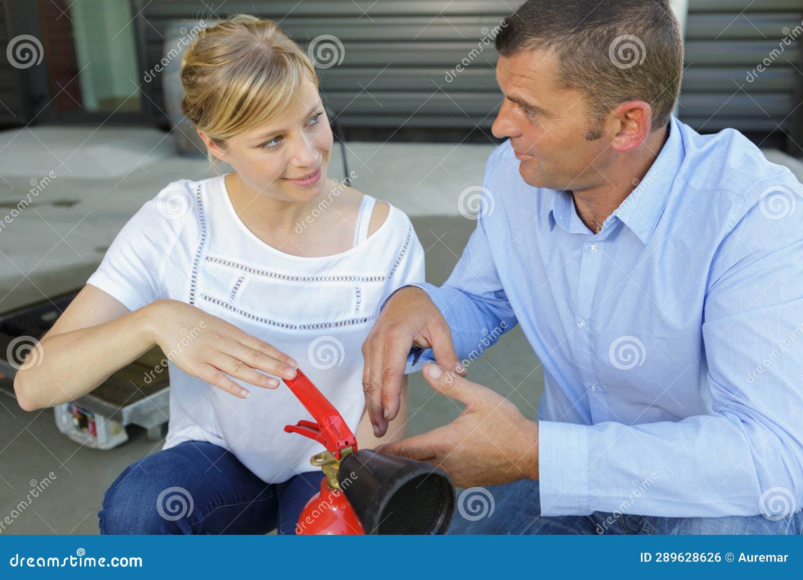 Learning To Use Fire Extinguisher Stock Photo - Image of pretty, danger ...