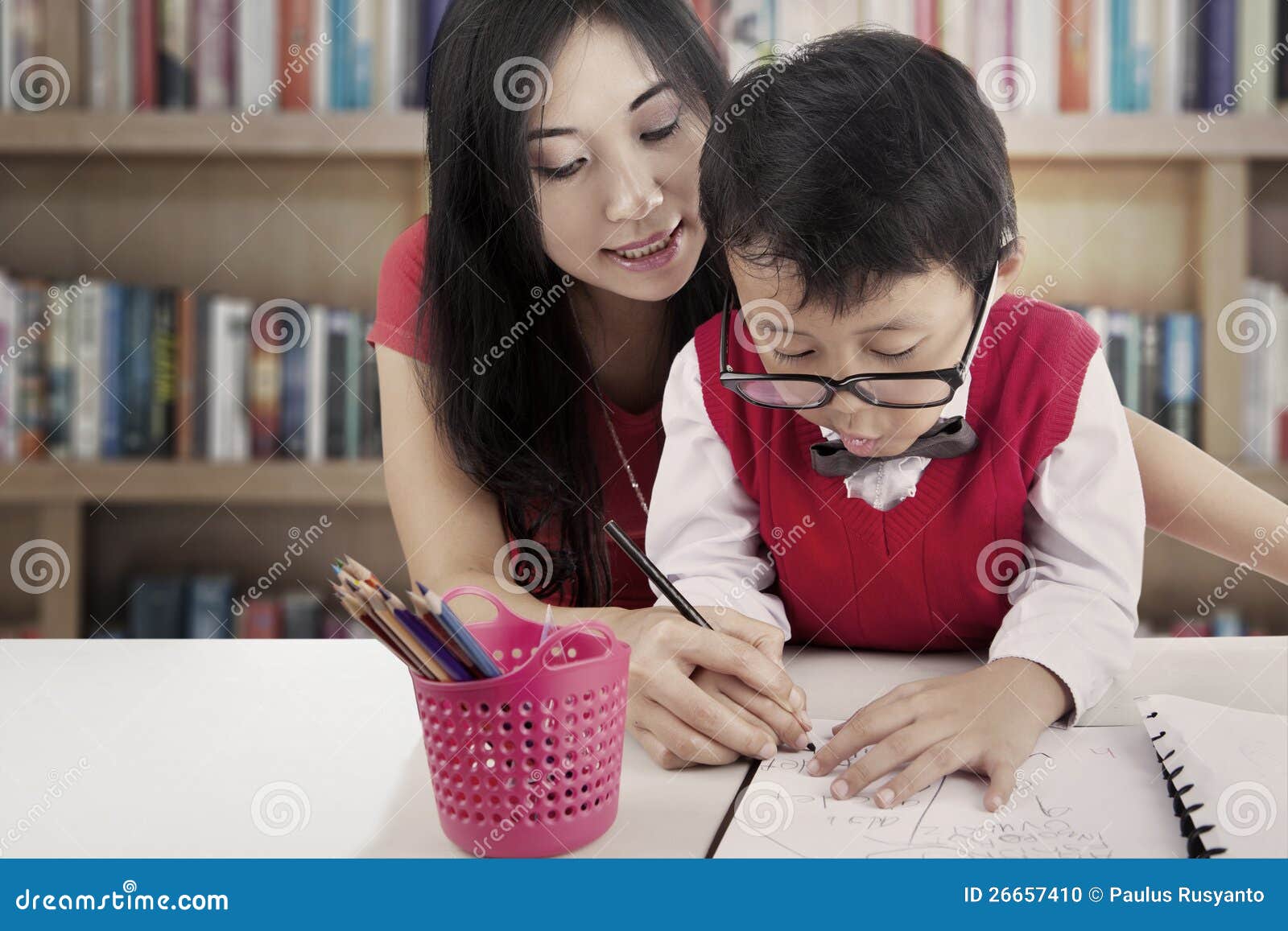 Learning To Write in Library Stock Photo - Image of mother, guide: 26657410