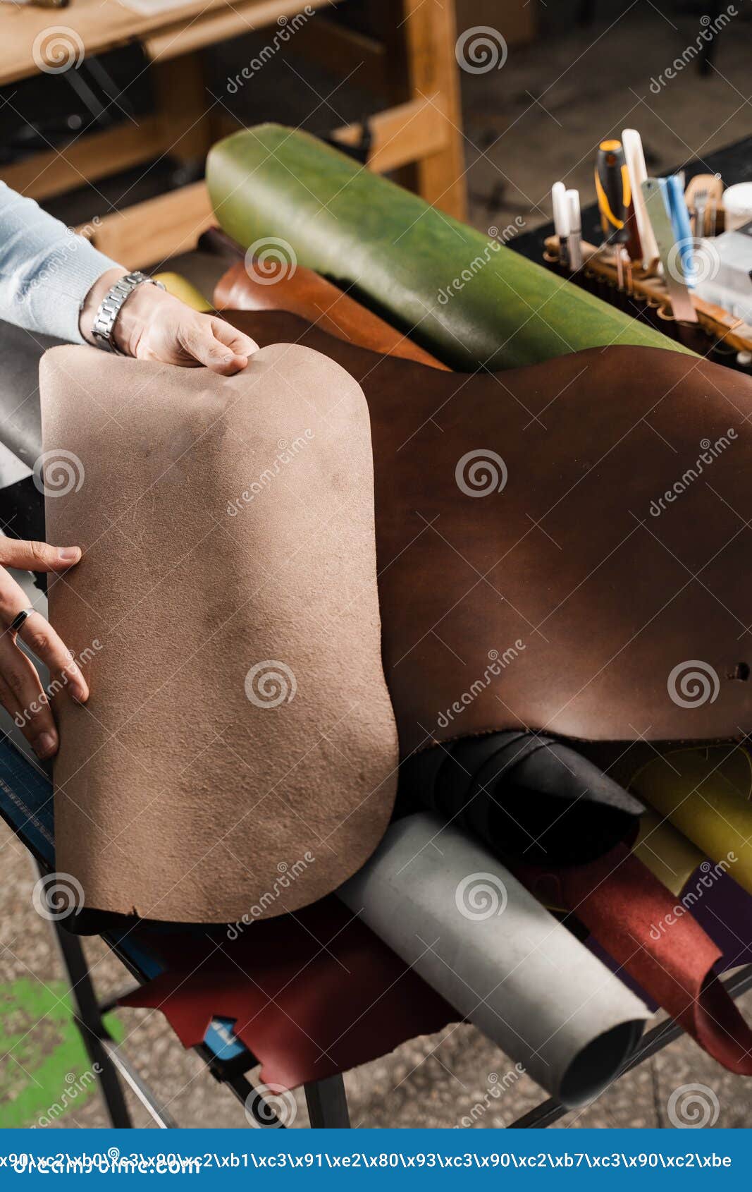 Leather Craftsman is Touching Roll of Genuine Leather in the Workshop ...