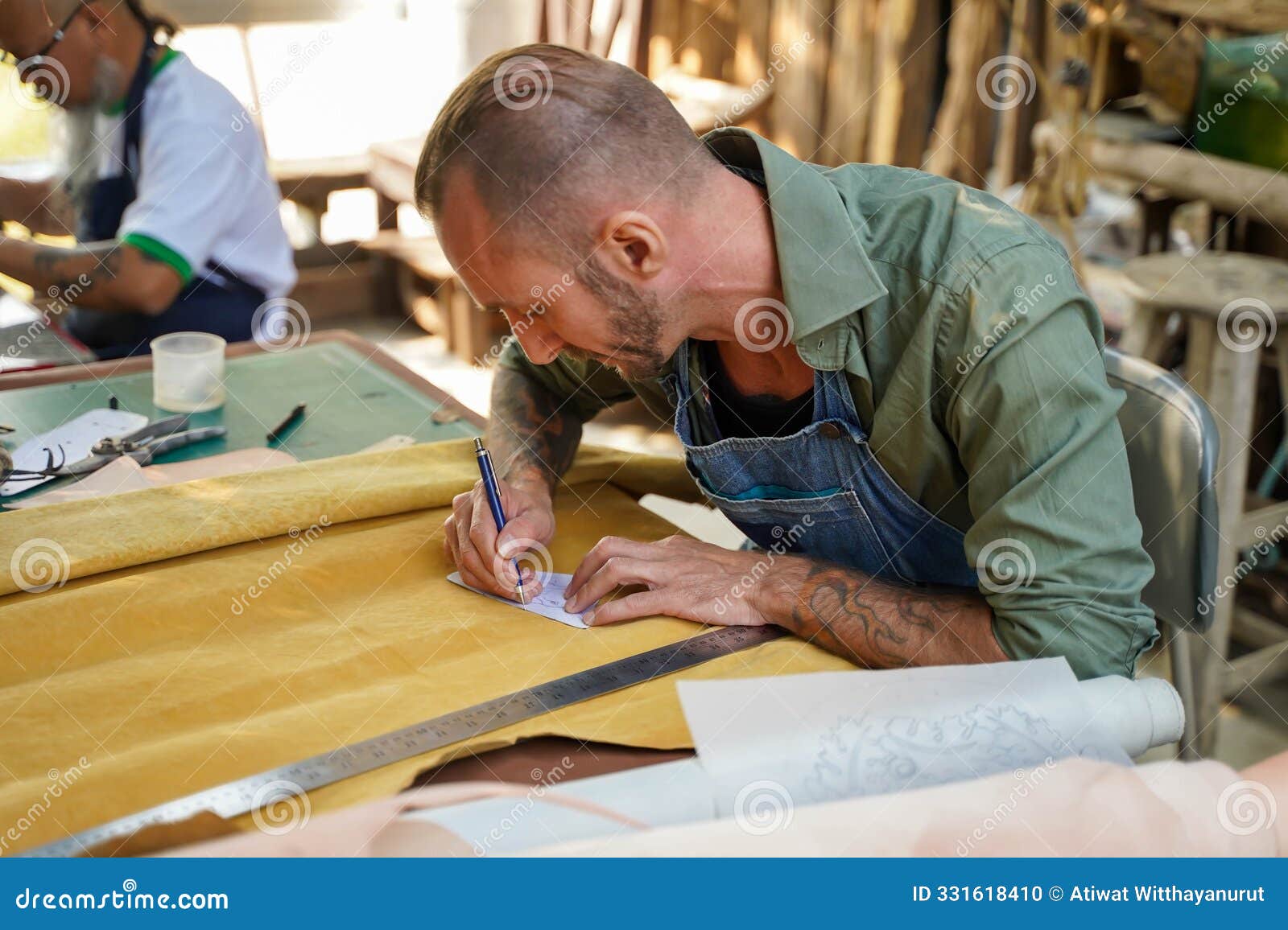 Leather Craftsman Using a Pencil Drawing Draft Design on the Yellow ...
