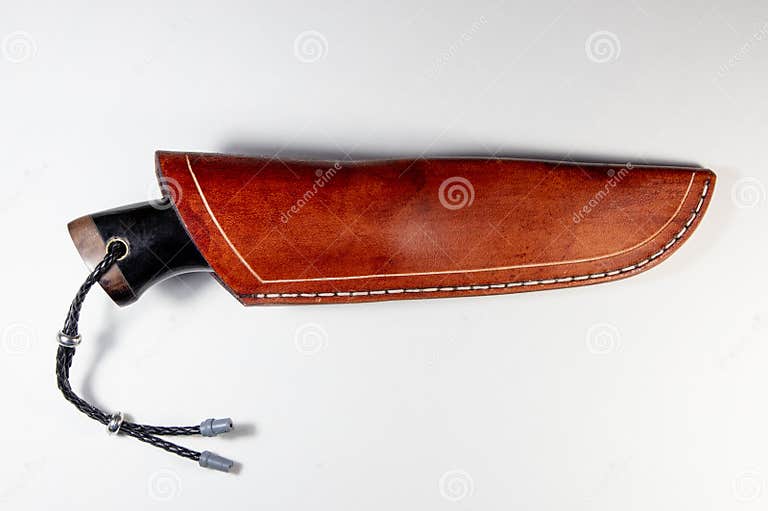 A Leather Knife Case Laying on a White Surface and Some String Stock ...