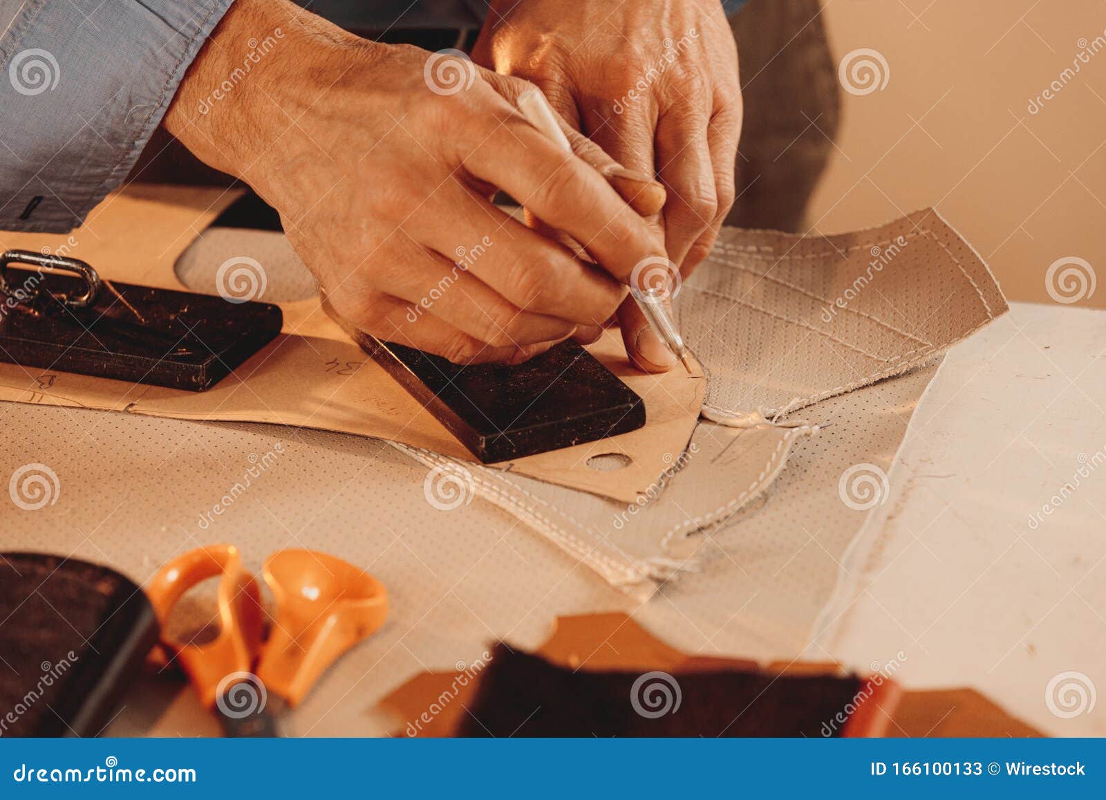 Leatherworker Making a Leather Clothing with White Fabric in a Studio ...