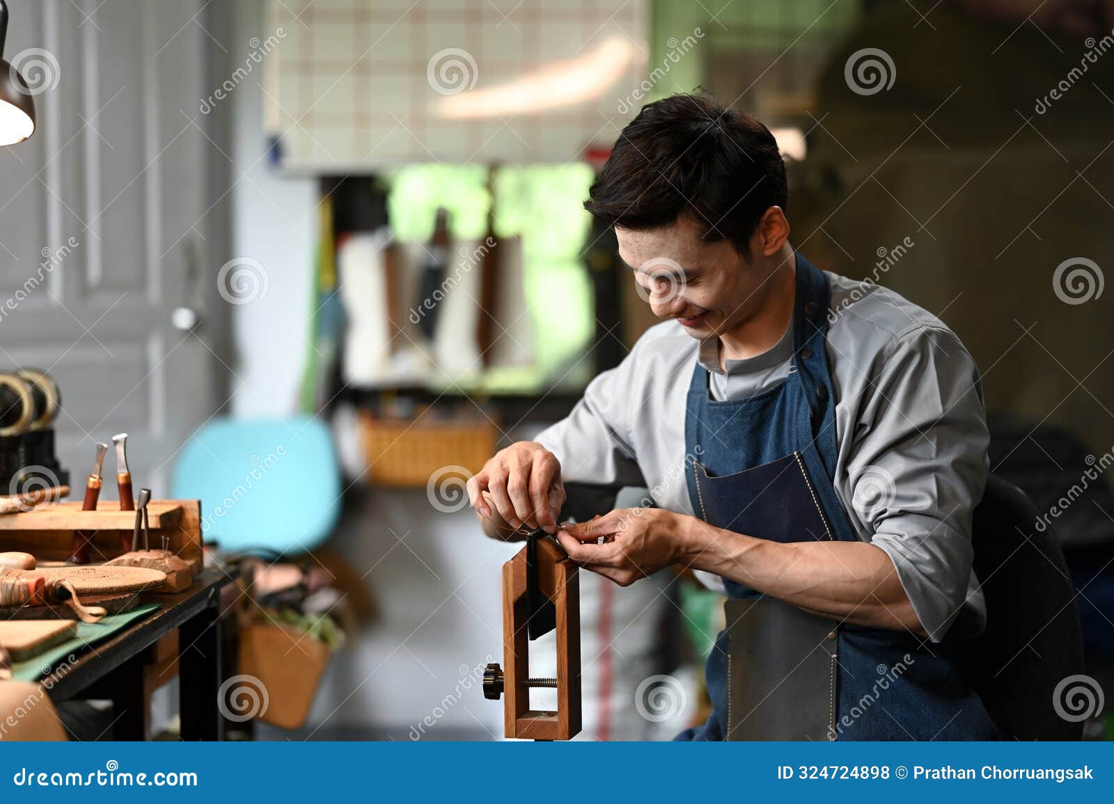 Leatherworker with a Needle Stitching Leather Product in a Special Vice ...