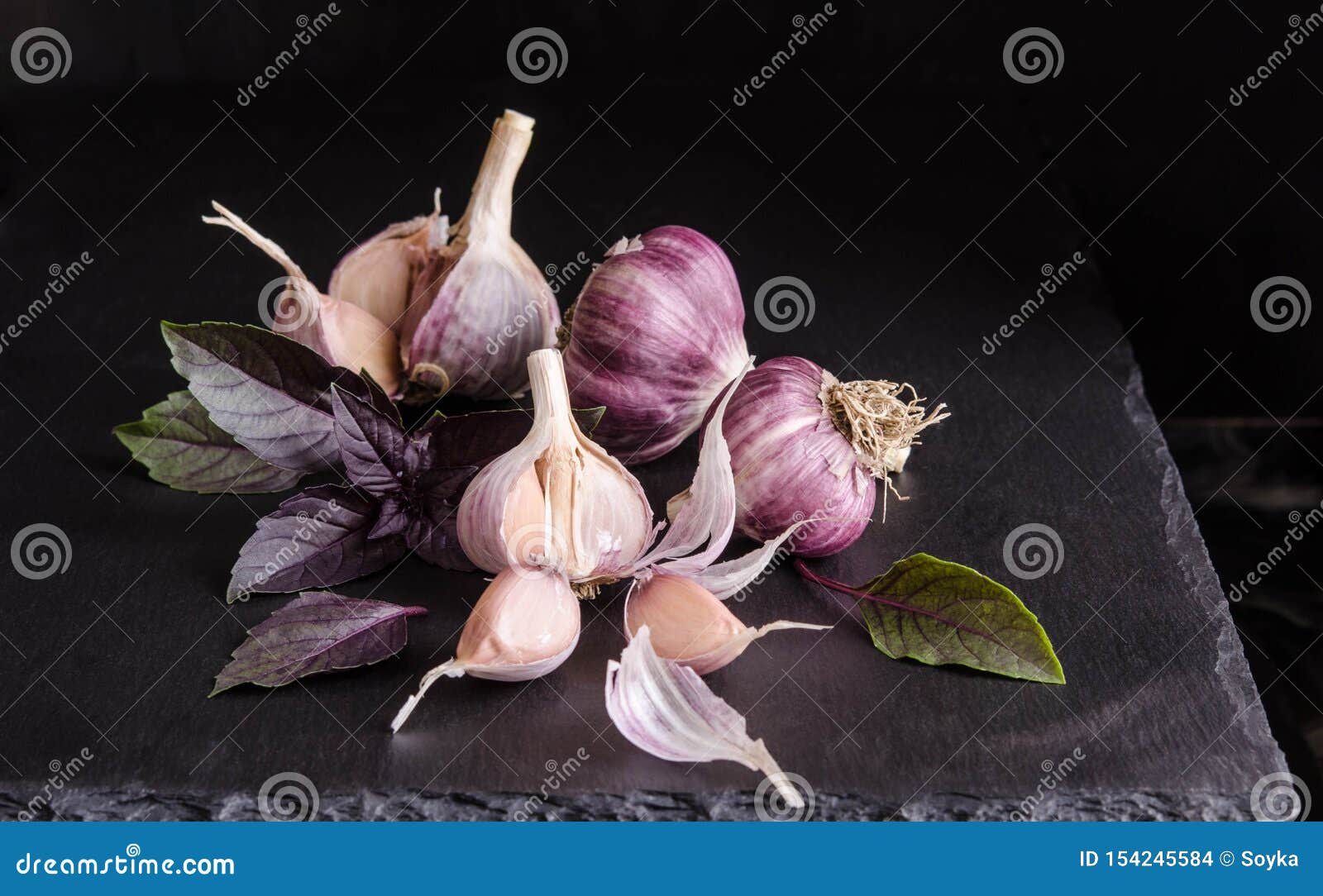 Leaves of Basil and Garlic on Black Stone Table Stock Photo - Image of ...
