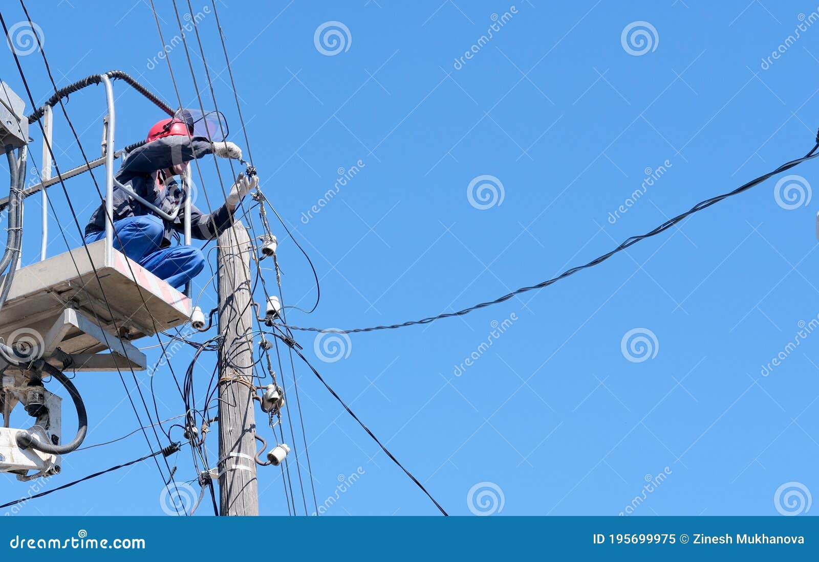 Lectrician Man Serves Electrical Lines and Pole at Height Using ...