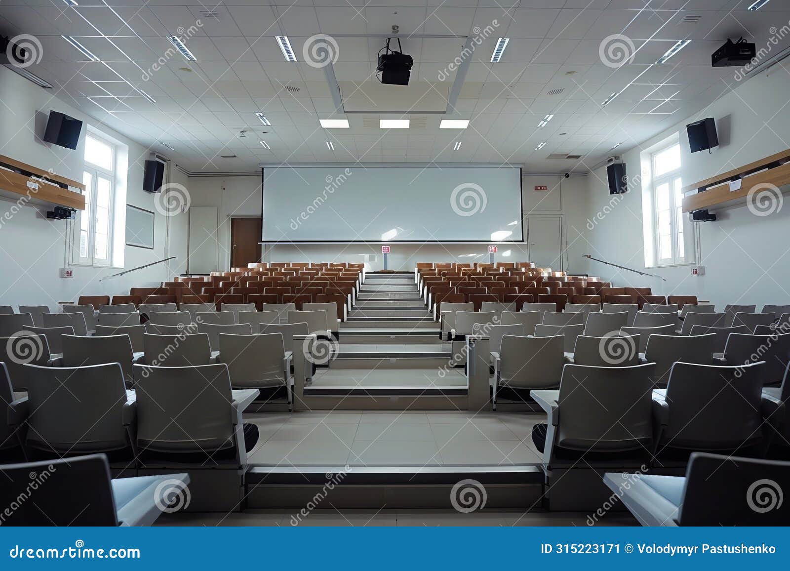 A Lecture Hall with Empty Seats and a Large Screen Stock Image - Image ...