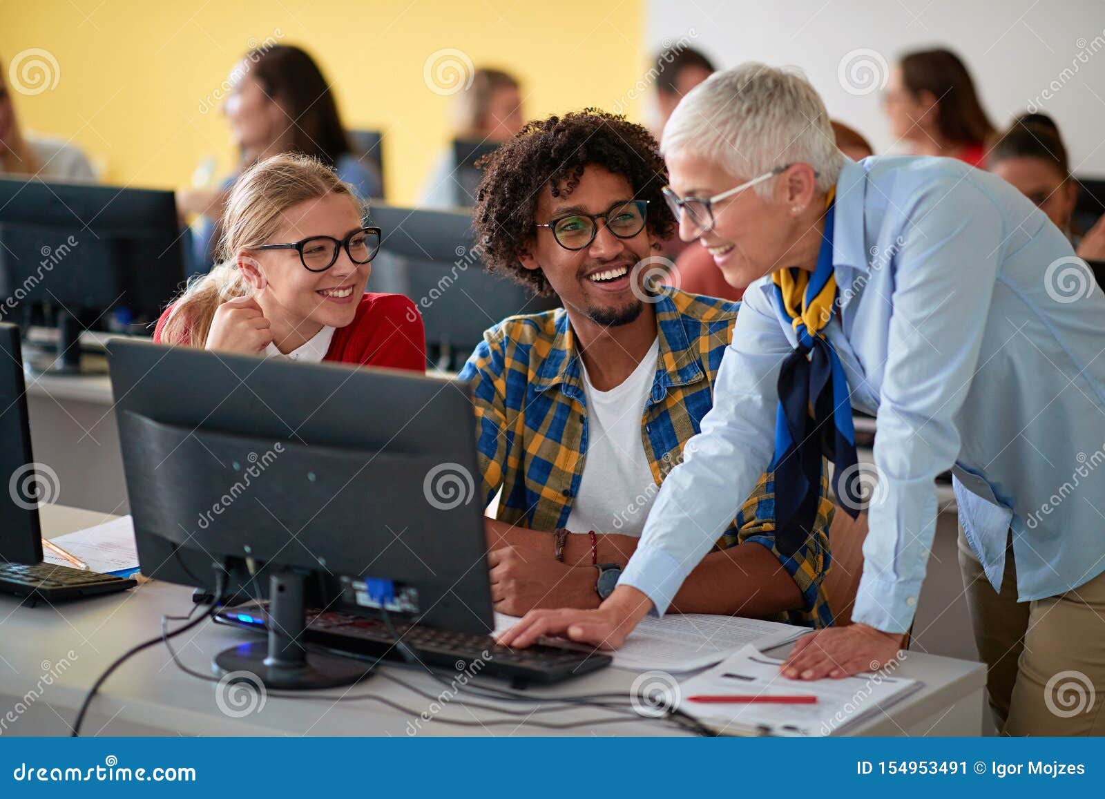 Lecturer with Group of Students Working in Computer Class on University ...