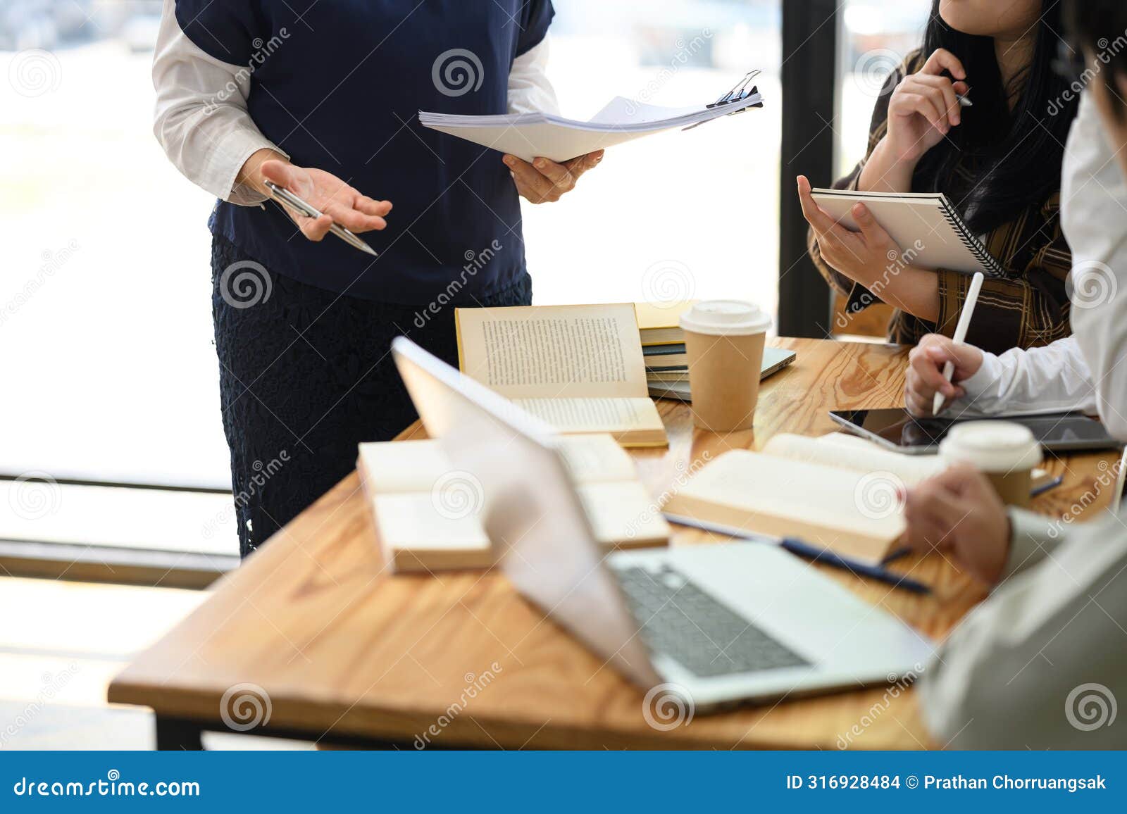 Lecturer Helping Group of Students with Project, Advising on Their Work ...