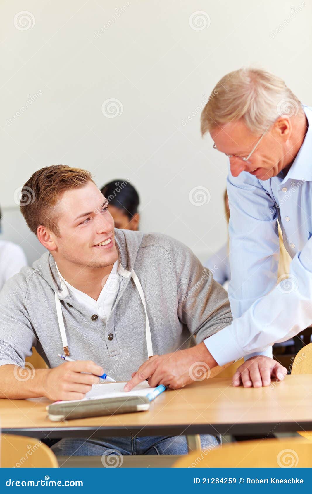 Lecturer helping a student stock image. Image of classroom - 21284259
