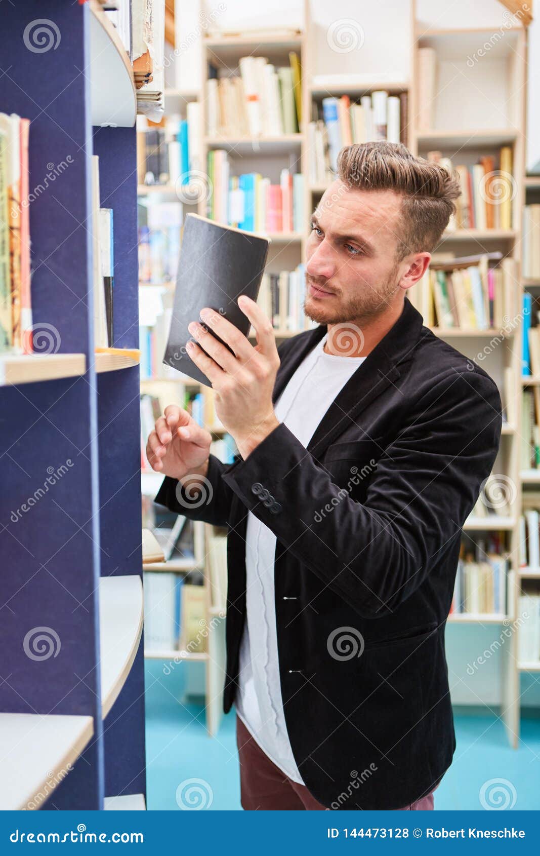 Lecturer or Librarian with Book in Front of a Shelf Stock Photo - Image ...