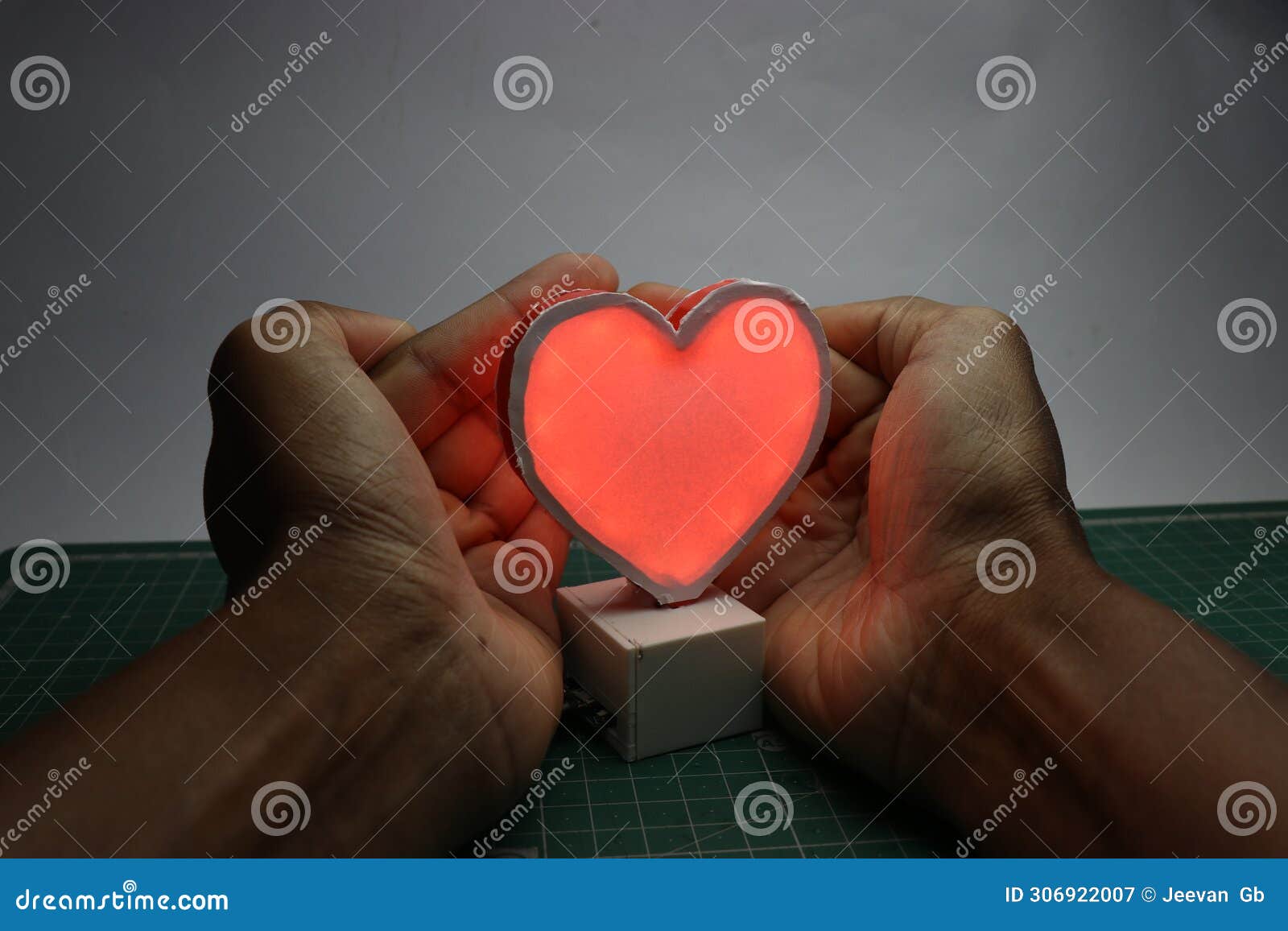LED Heart Made Using 3D Print Technology Being Covered with Hands ...