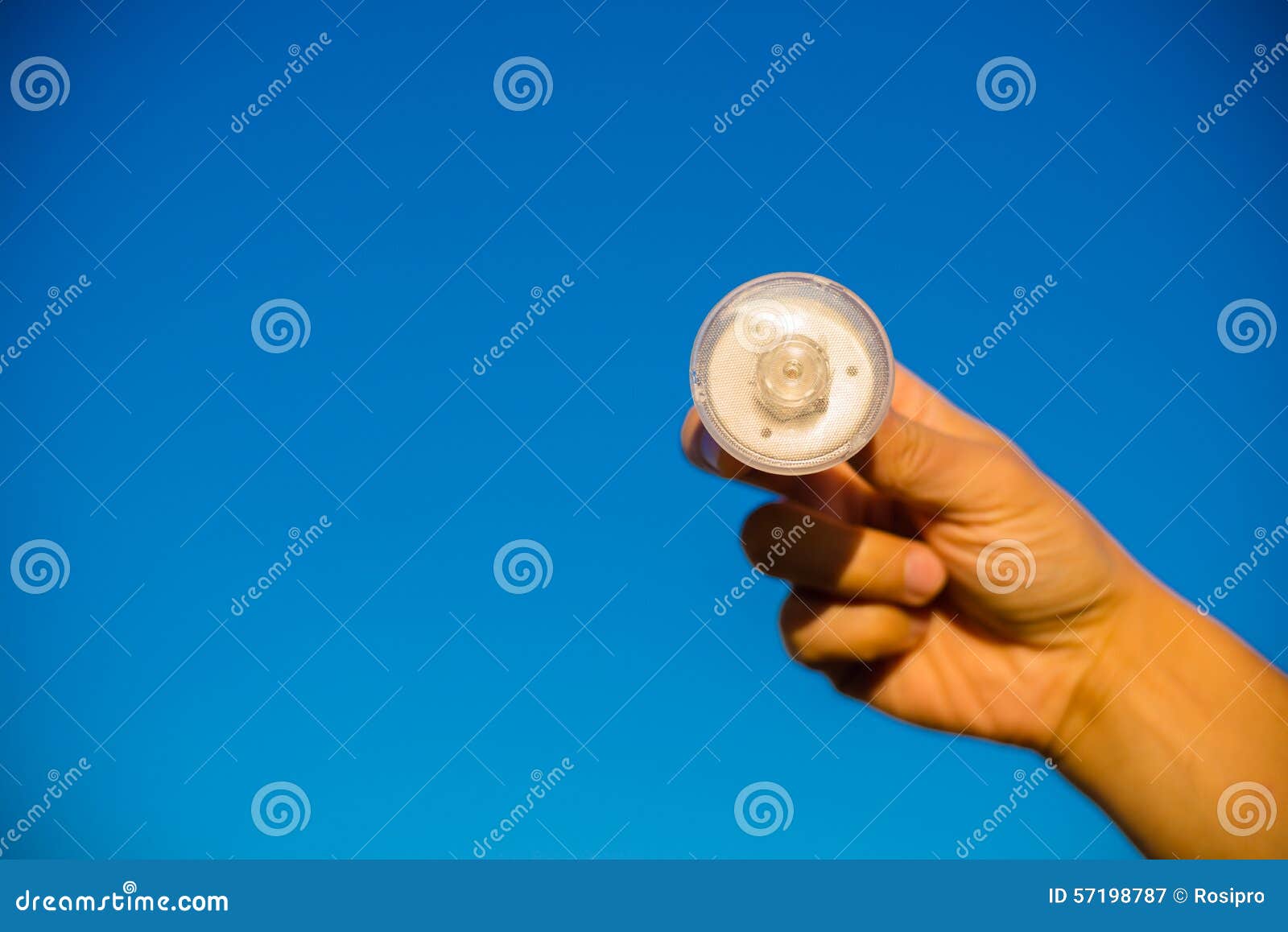 LED Lamp in Hand Against Blue Sky Stock Image - Image of abstract ...