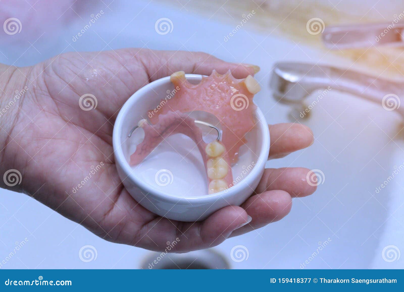 Left Hand Hold Upper And Lower Teeth Partial Dentures Royalty-Free ...