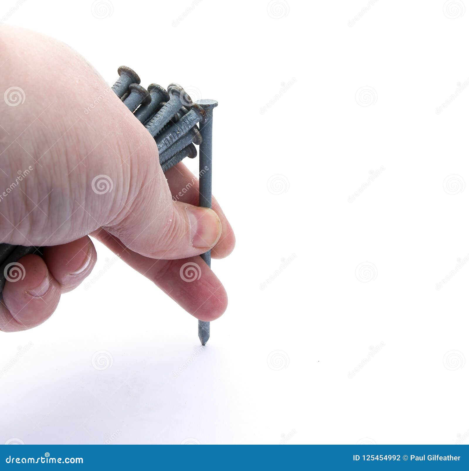 Left Hand Holding Nails with One Ready for Use Held between Finger and ...