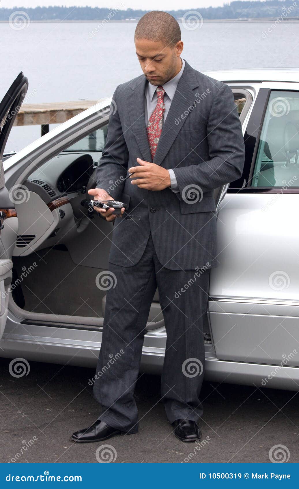 Left Handed Ethnic Business Man Using PDA Stock Image - Image of handed ...