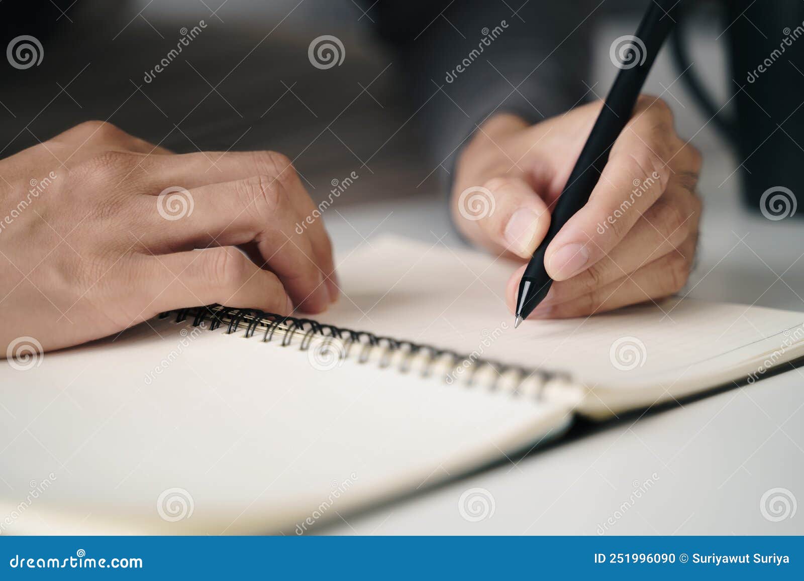 Left Handed Man Writes in a Notebook on the Table Stock Photo - Image ...