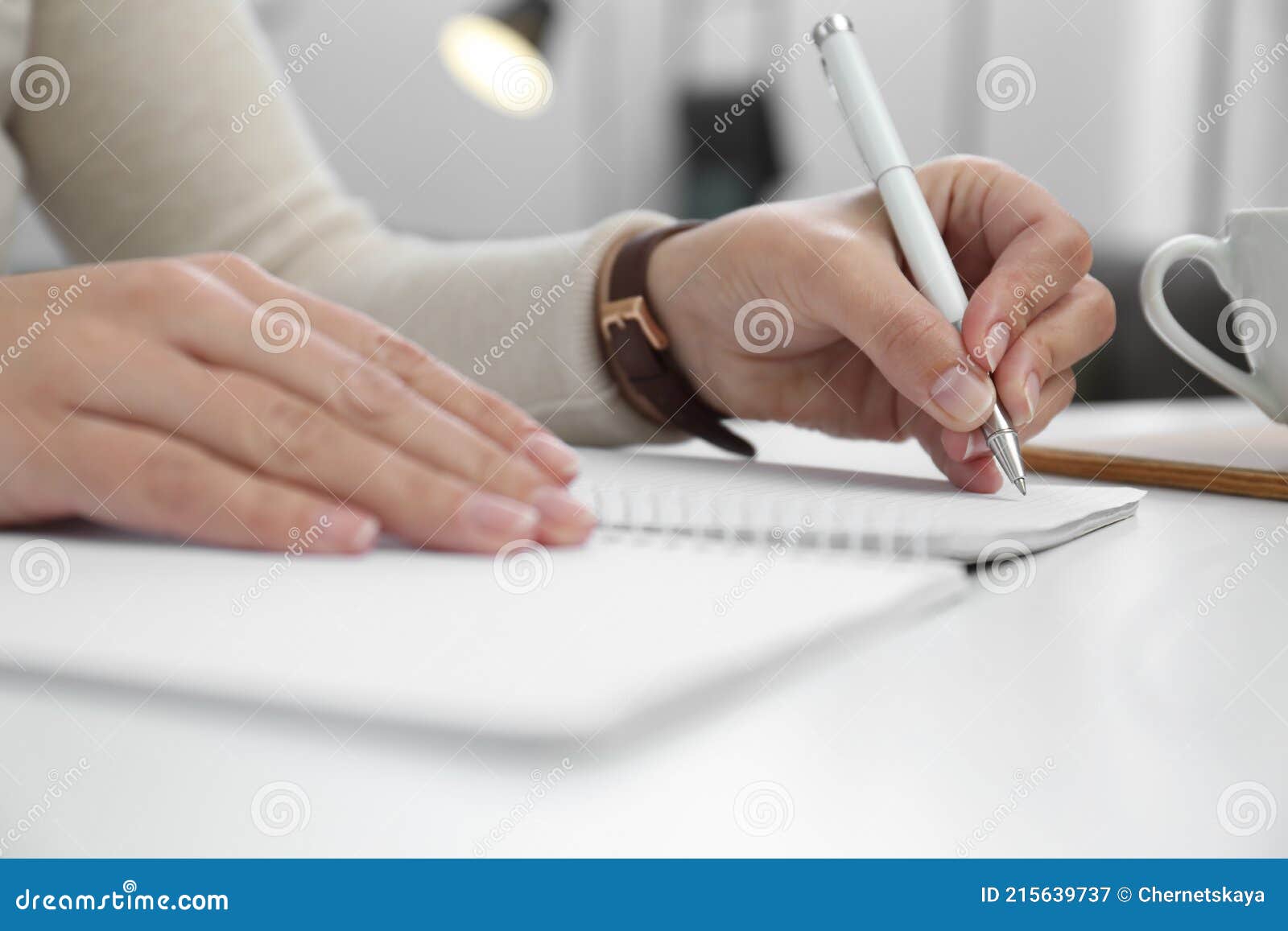 Left-handed Woman Writing in Notebook at Table Indoors, Closeup Stock ...