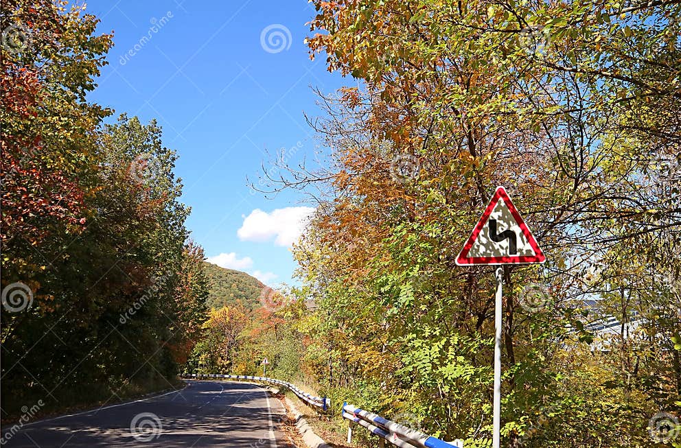 Left Reverse Bend Road Sign on the Windy Mountain Road among Fall ...